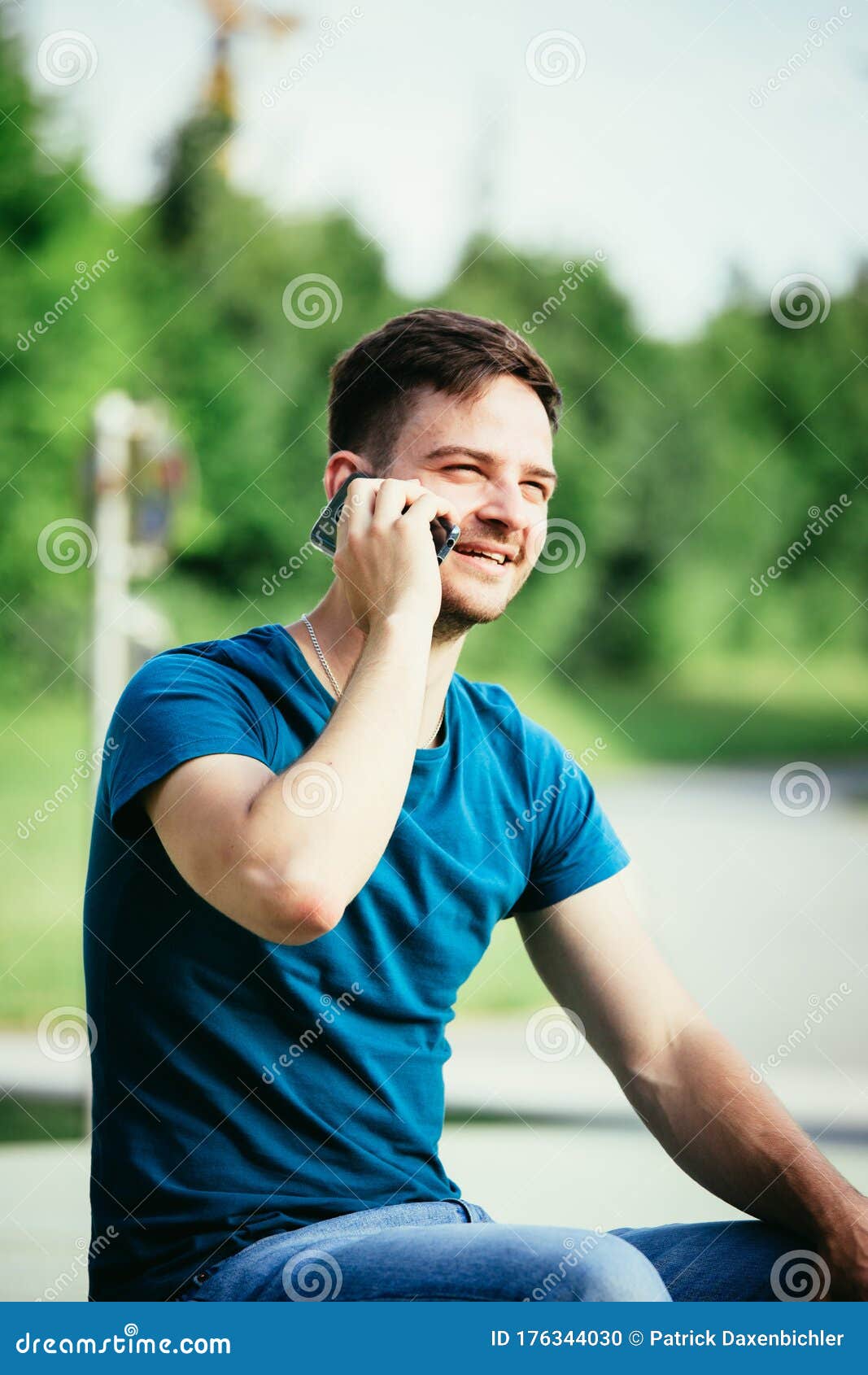 Young Man Calling Outdoors: Handsome Young Man is Sitting and Calling ...