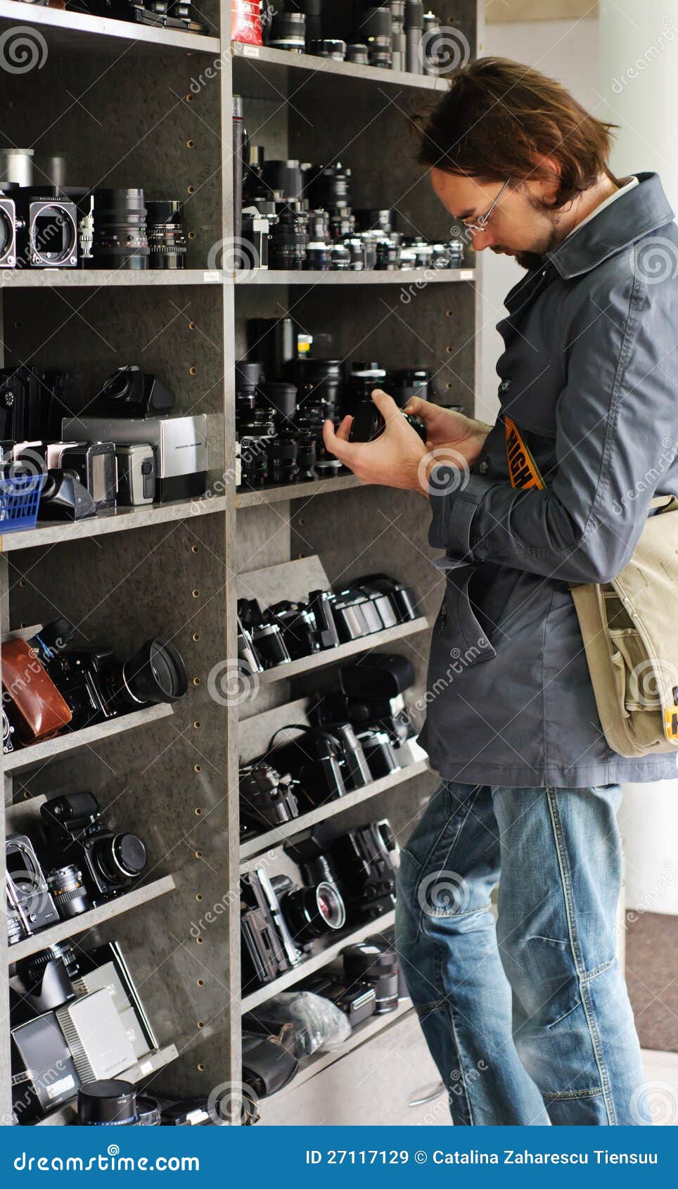 Young Man in a Cameras Shop Stock Image - Image of checking, shelves ...