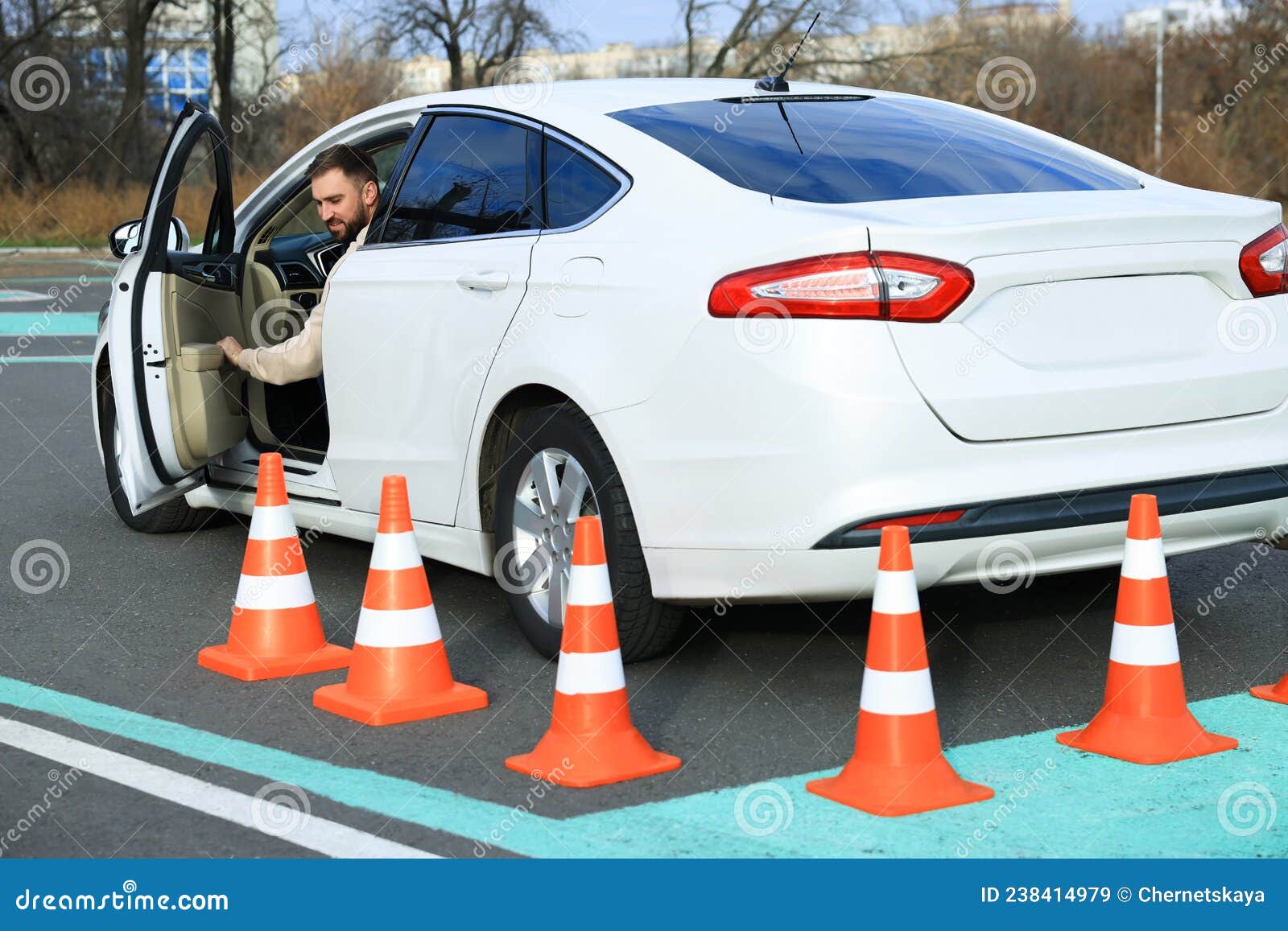 Young Man in Car on Test Track with Traffic Cones. Driving School Stock ...