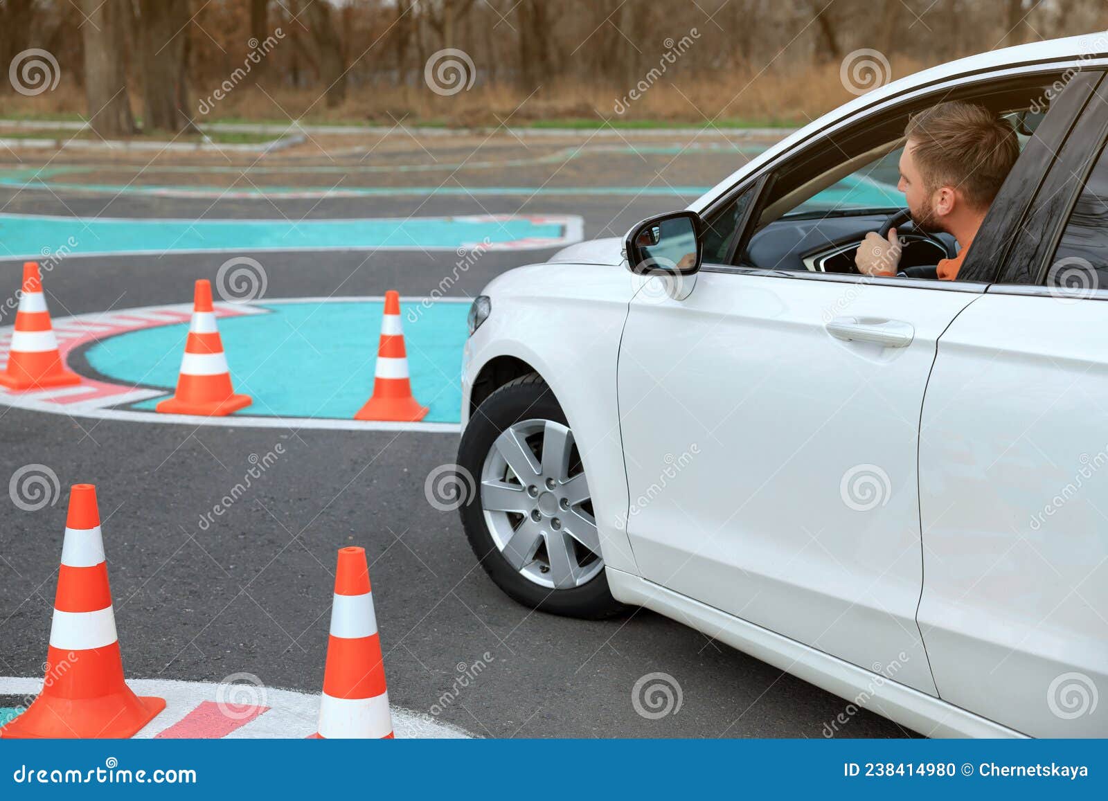 Young Man in Car on Test Track with Traffic Cones. Driving School Stock ...