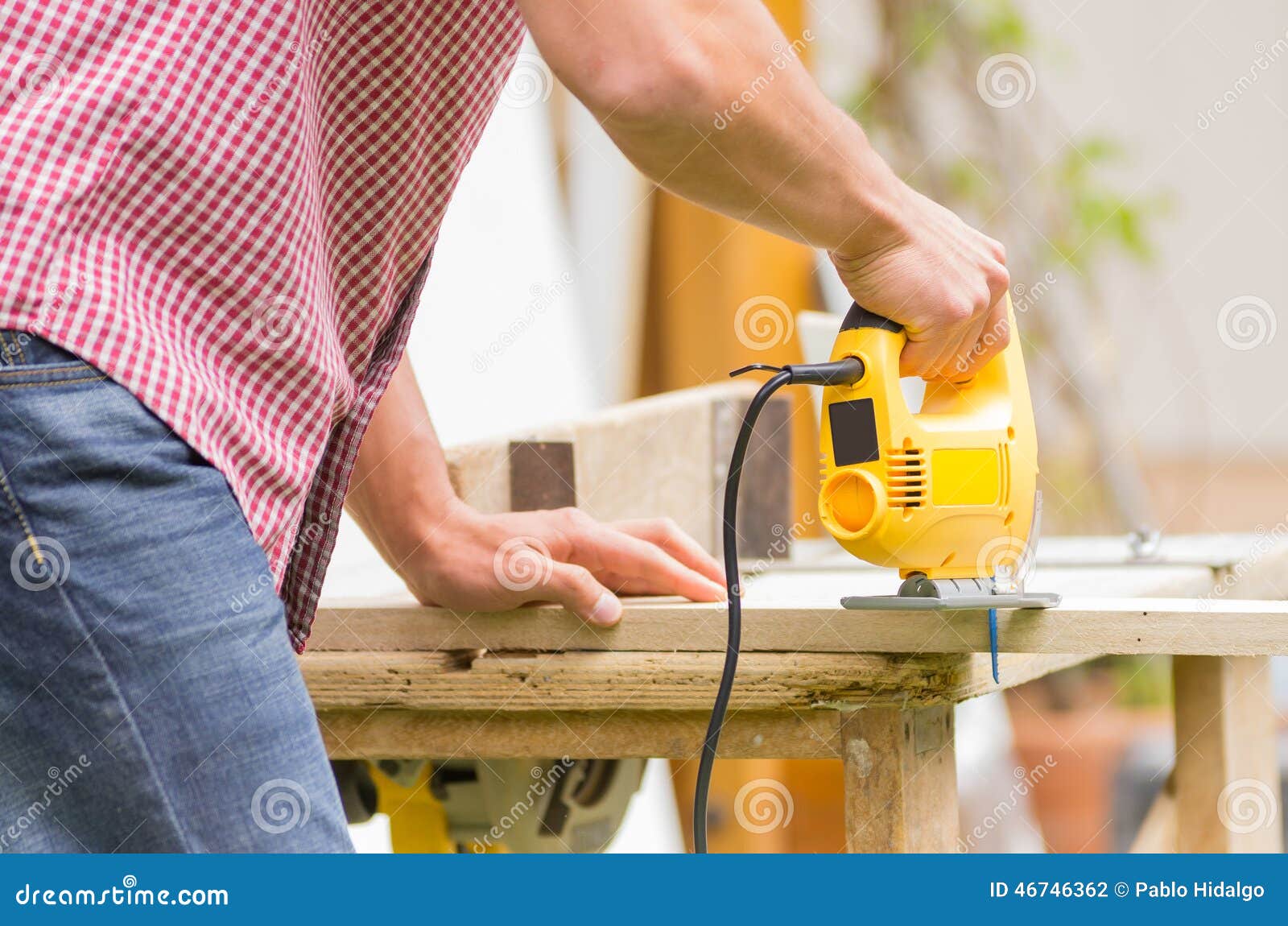 Young Man Carpenter Working with Electric Jigsaw Stock Photo - Image of ...