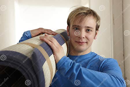 Young man carrying carpet stock image. Image of moves - 11719887