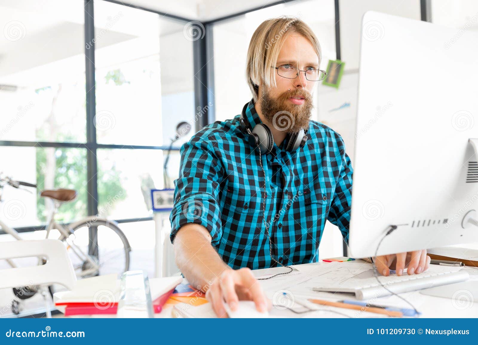 Young Man Working in Office Stock Photo - Image of sitting, portrait ...