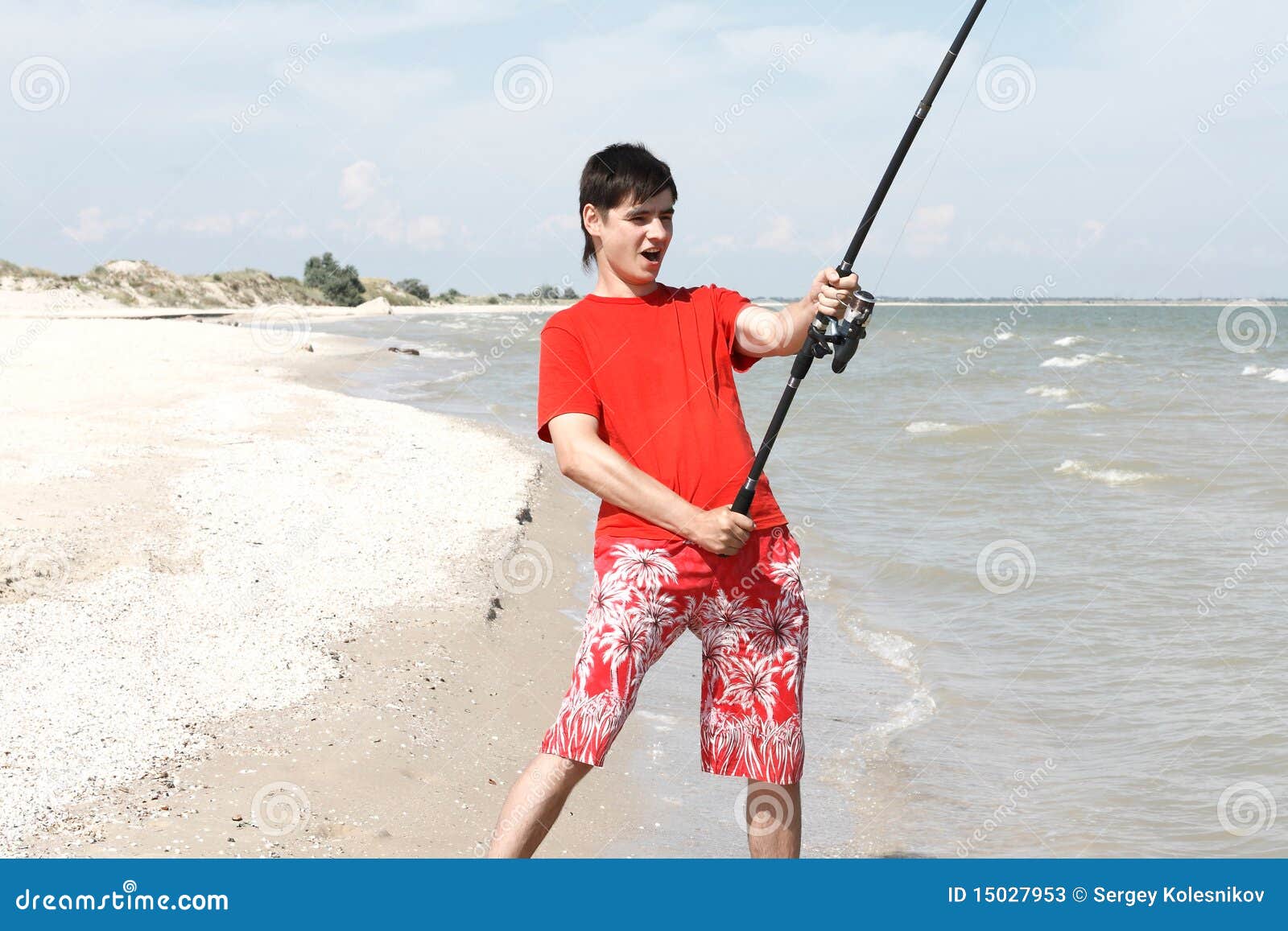 A young man catches a fish stock image. Image of clouds - 15027953