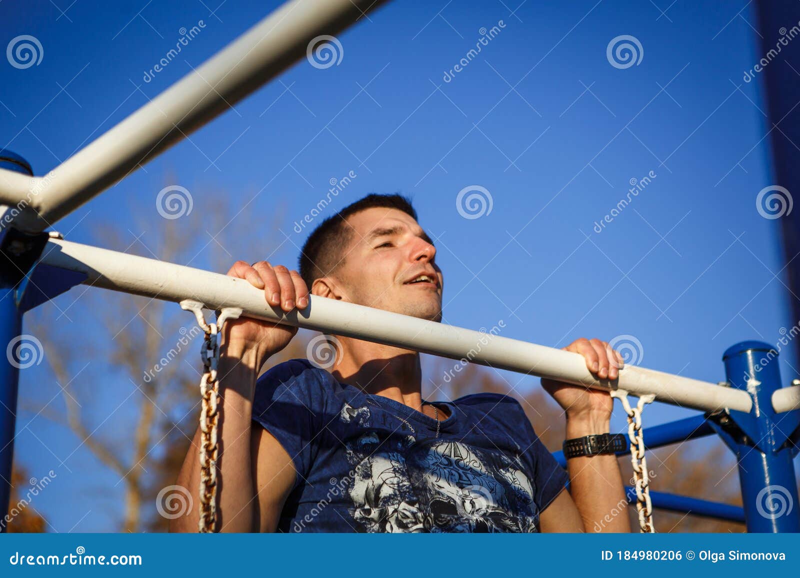 A Young Man of Caucasian Appearance Pulls Himself Up on a Horizontal ...