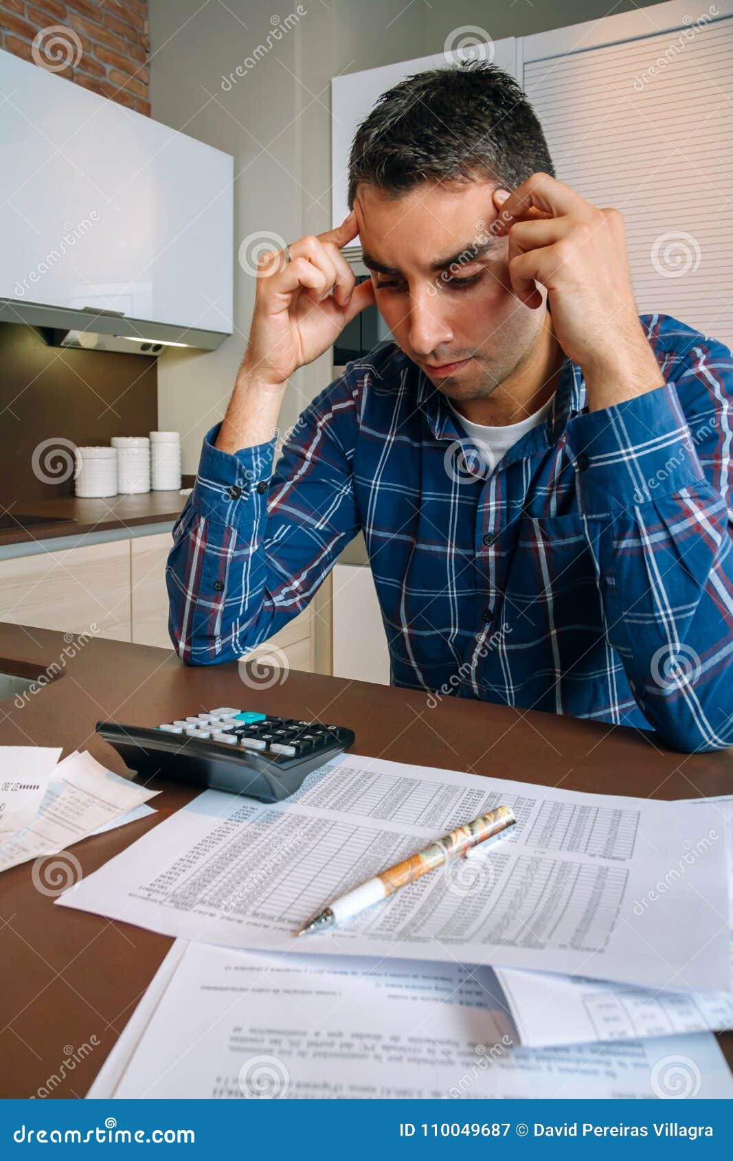 Young man checking bills stock image. Image of lifestyle - 110049687