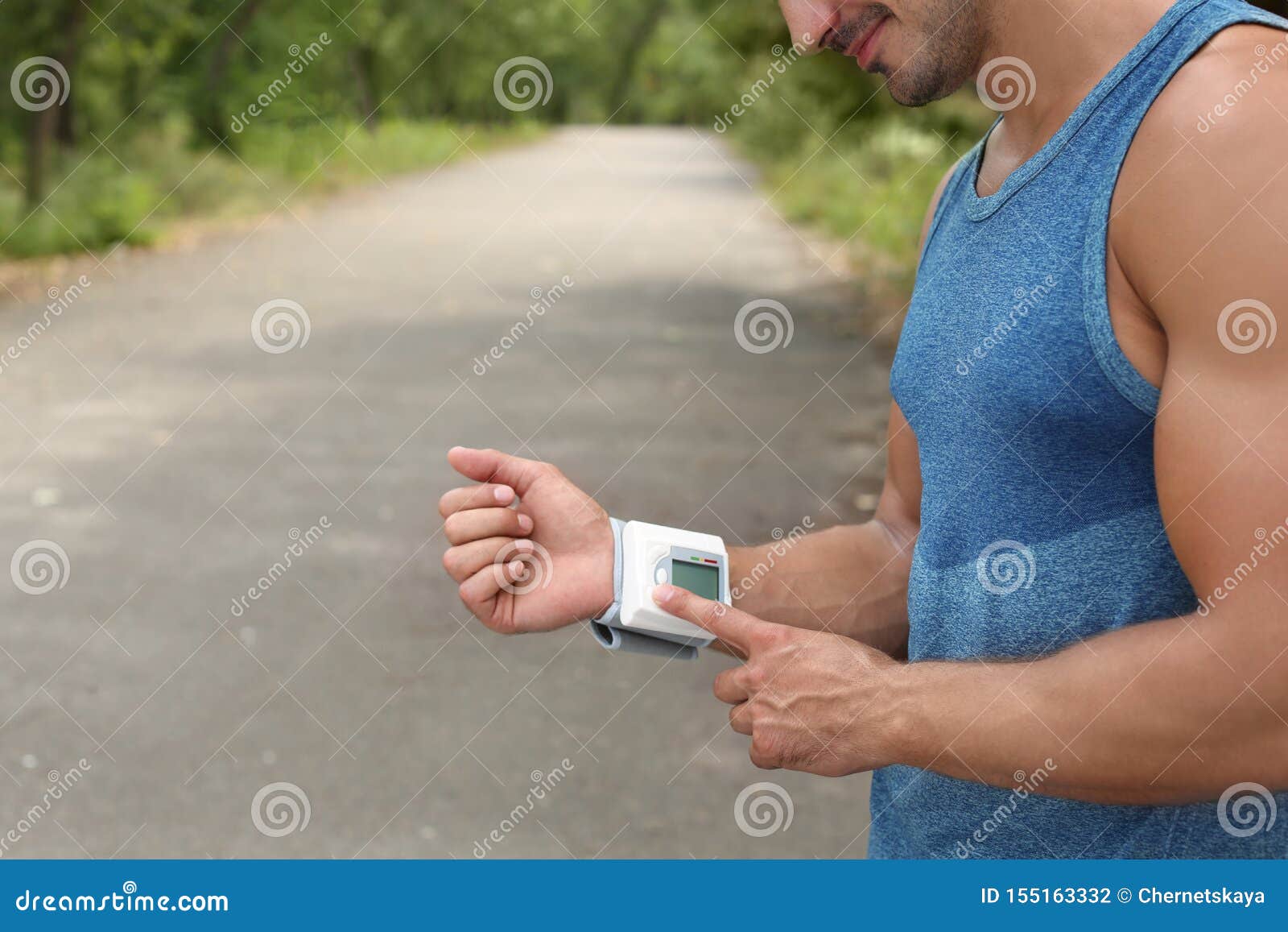 Young Man Checking Pulse with Device after Training in Park, Closeup ...