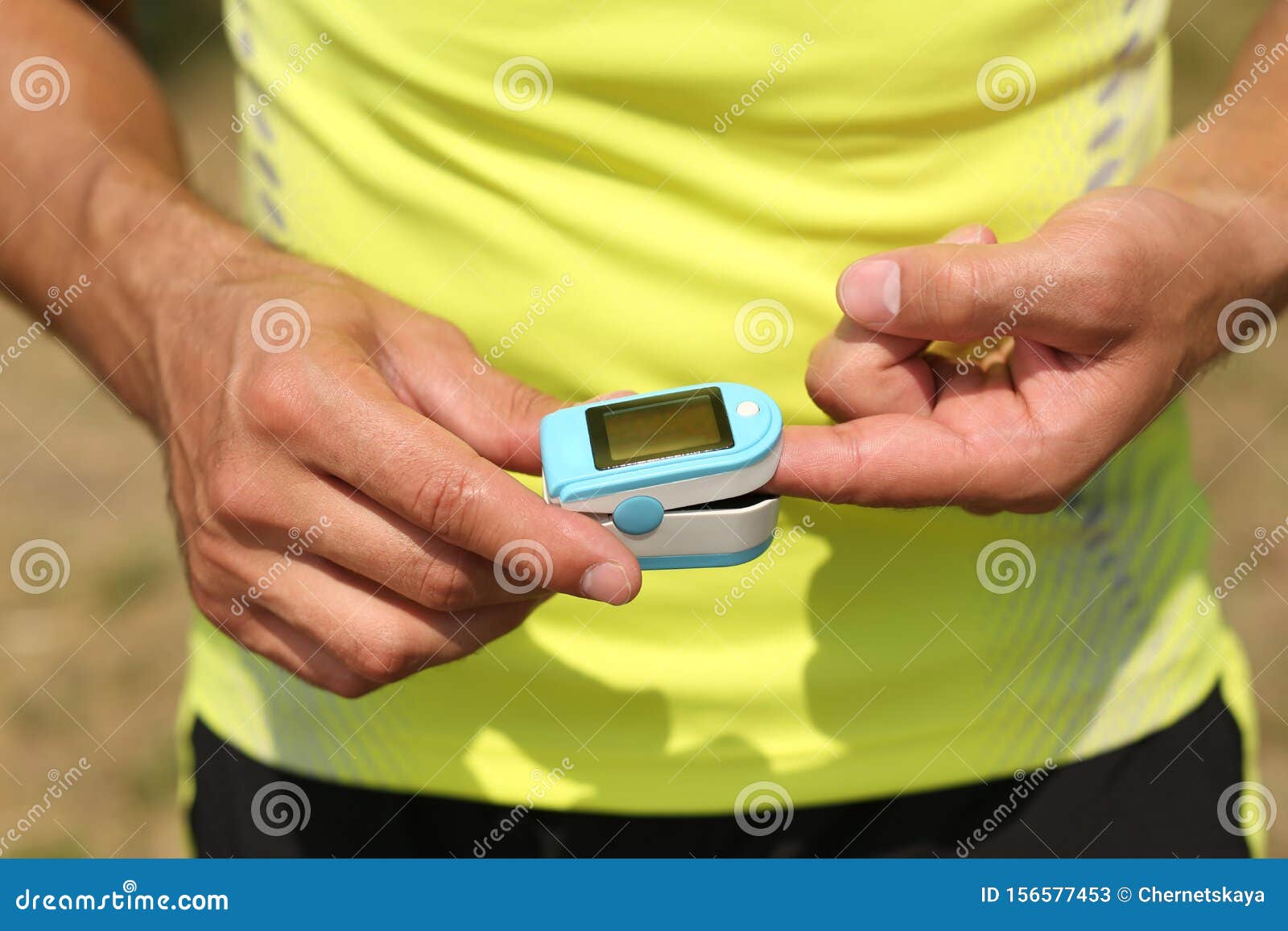 Young Man Checking Pulse with Device after Training Outdoors, Closeup ...
