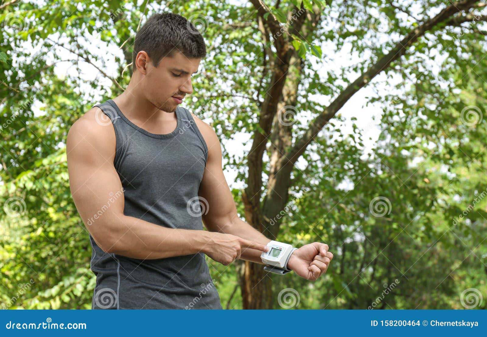 Young Man Checking Pulse Medical Device after Training Outdoors Stock ...