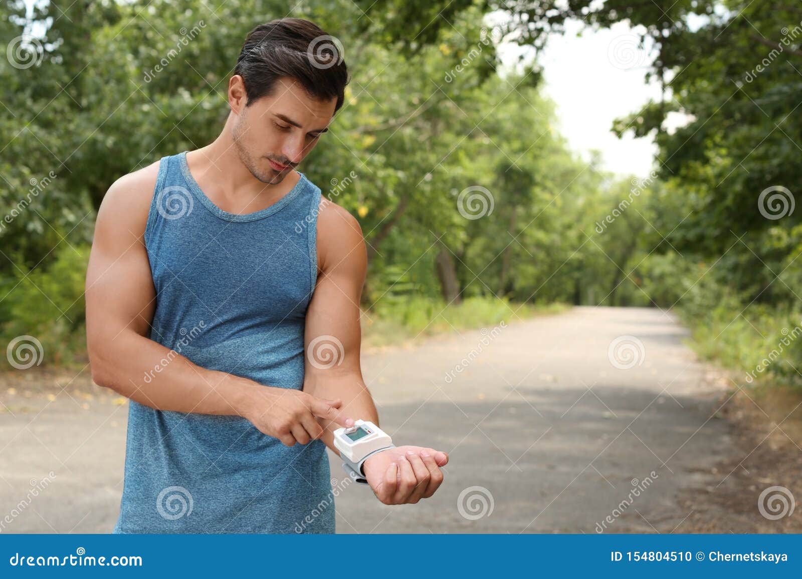 Young Man Checking Pulse with Medical Device after Training in Park ...