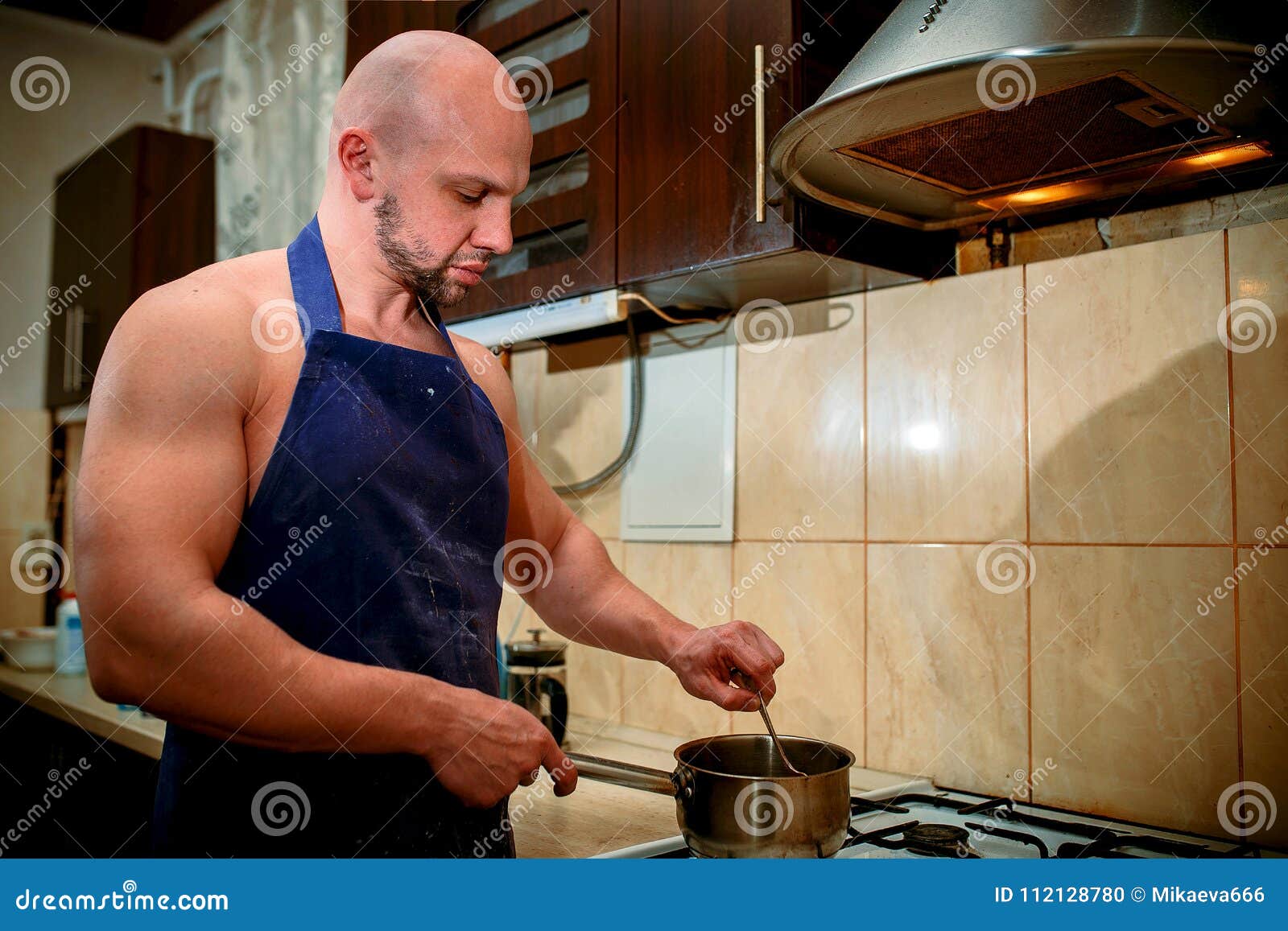 A Young Man Chef Stands Behind a Stove Stock Photo - Image of cook ...