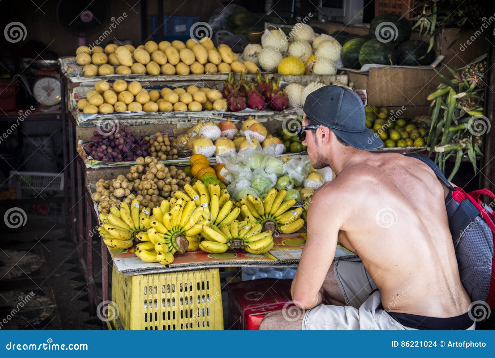 Young man choosing fruits stock photo. Image of muscular - 86221024
