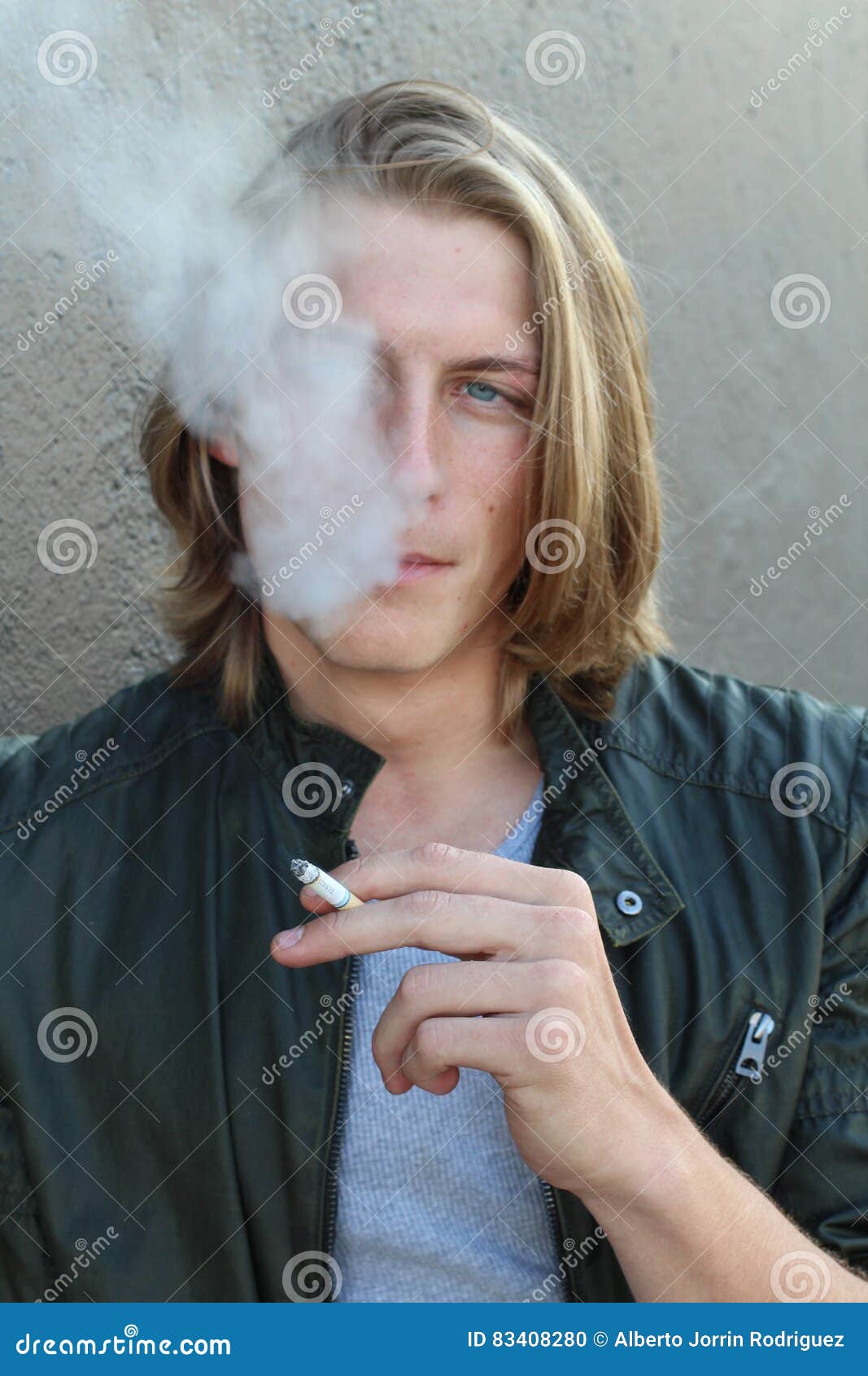 Young Man with Cigarette Isolated on the Urban Background Stock Photo ...