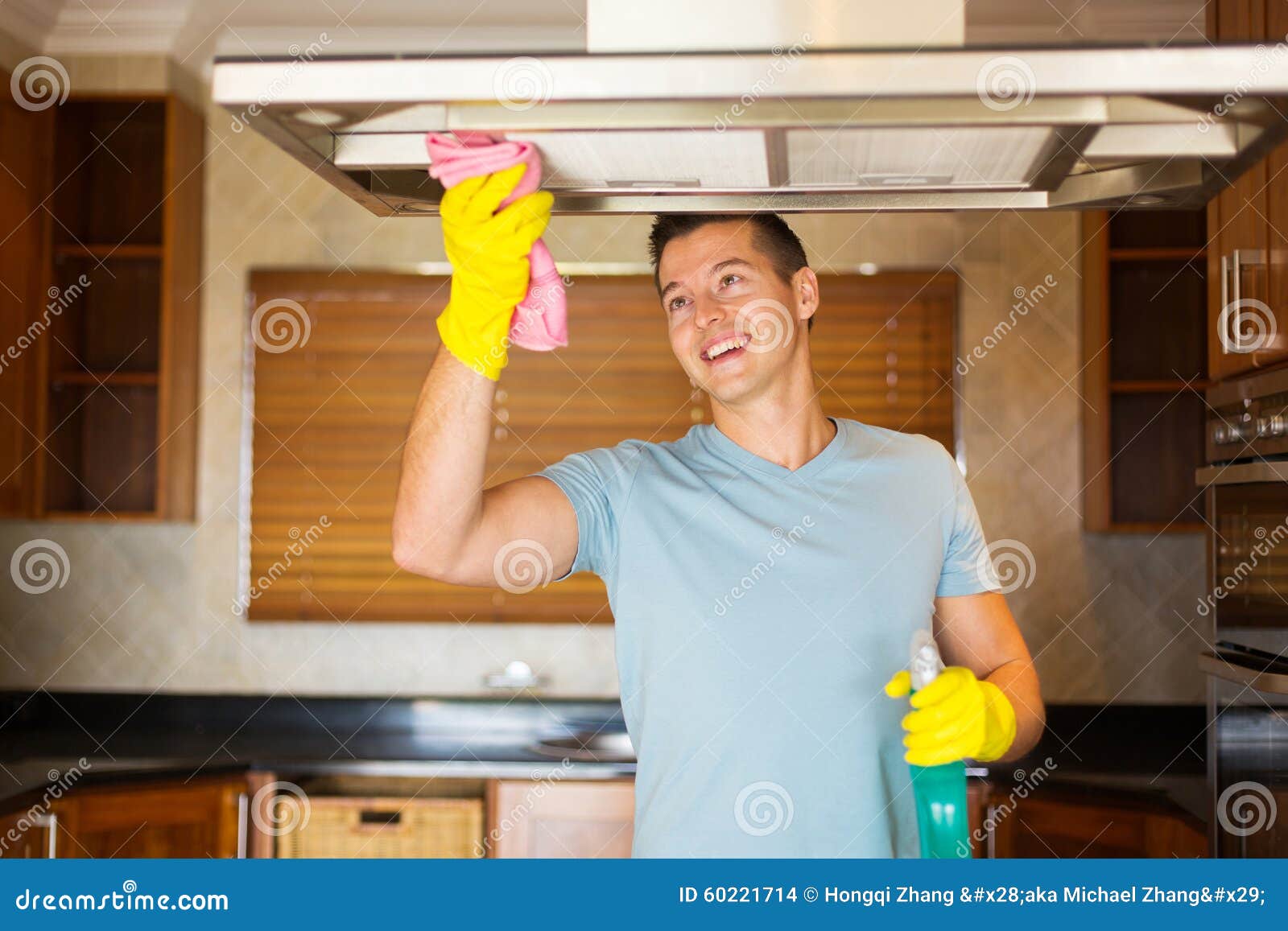 Young man cleaning kitchen stock photo. Image of happy - 60221714