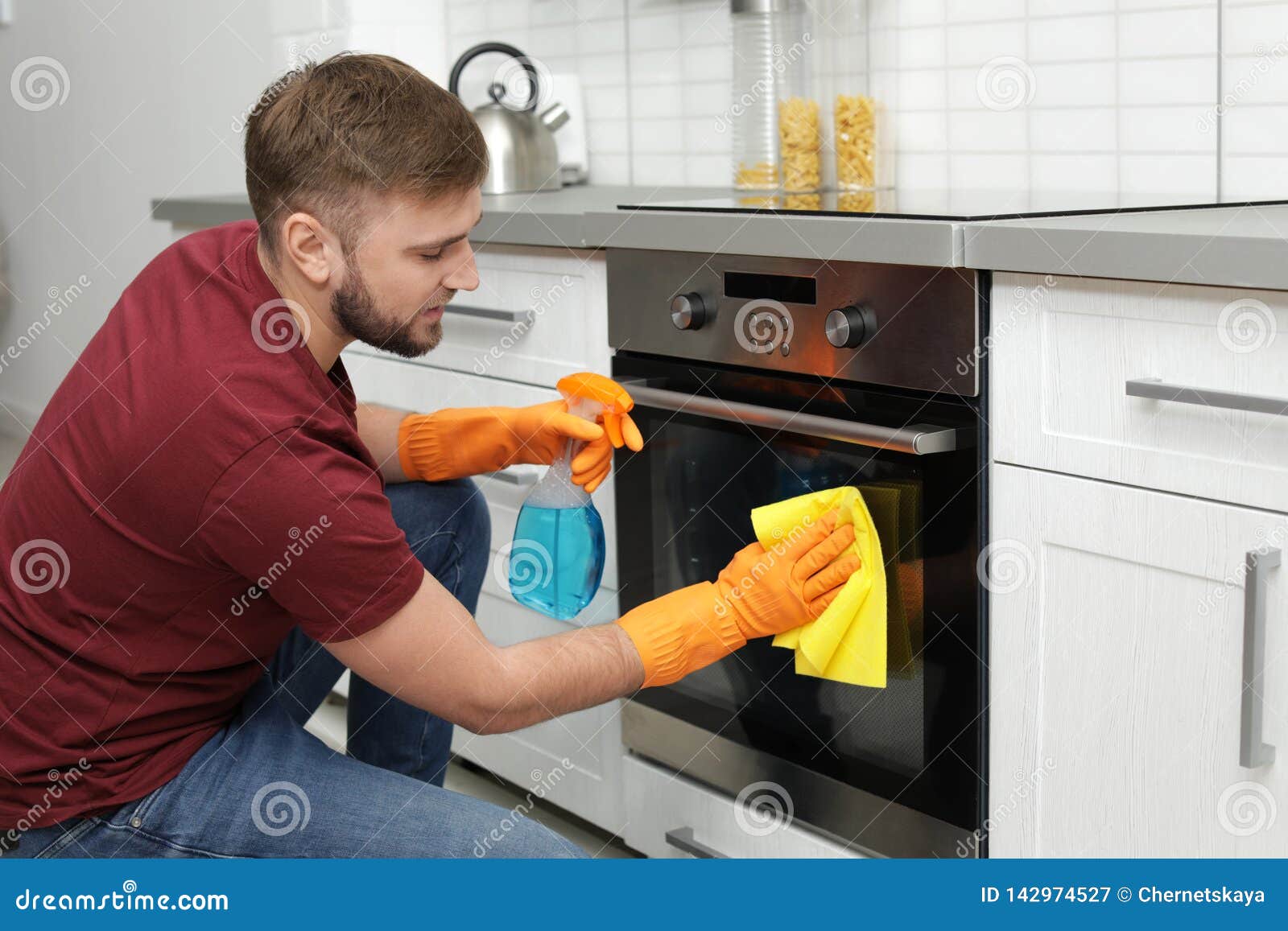 Young Man Cleaning Oven with Rag Stock Image - Image of adult, chores ...