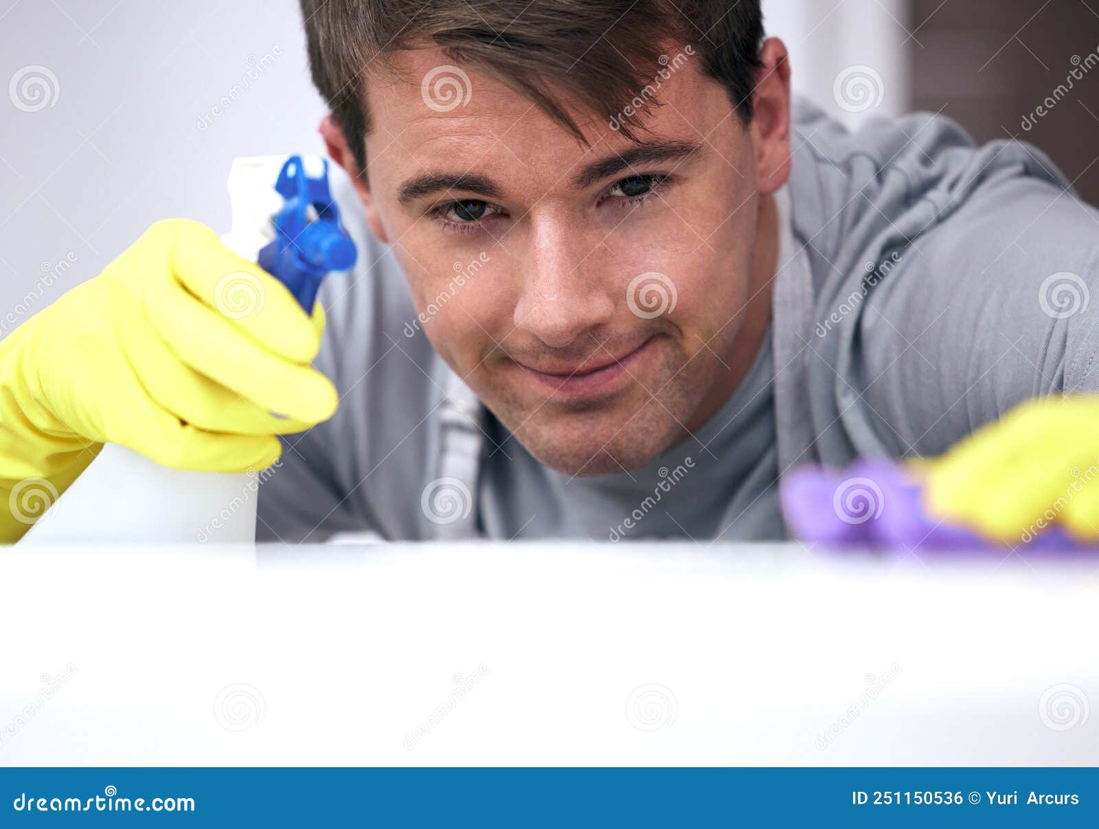 Lets Take a Closer Look. a Young Man Cleaning a Surface at Home. Stock ...