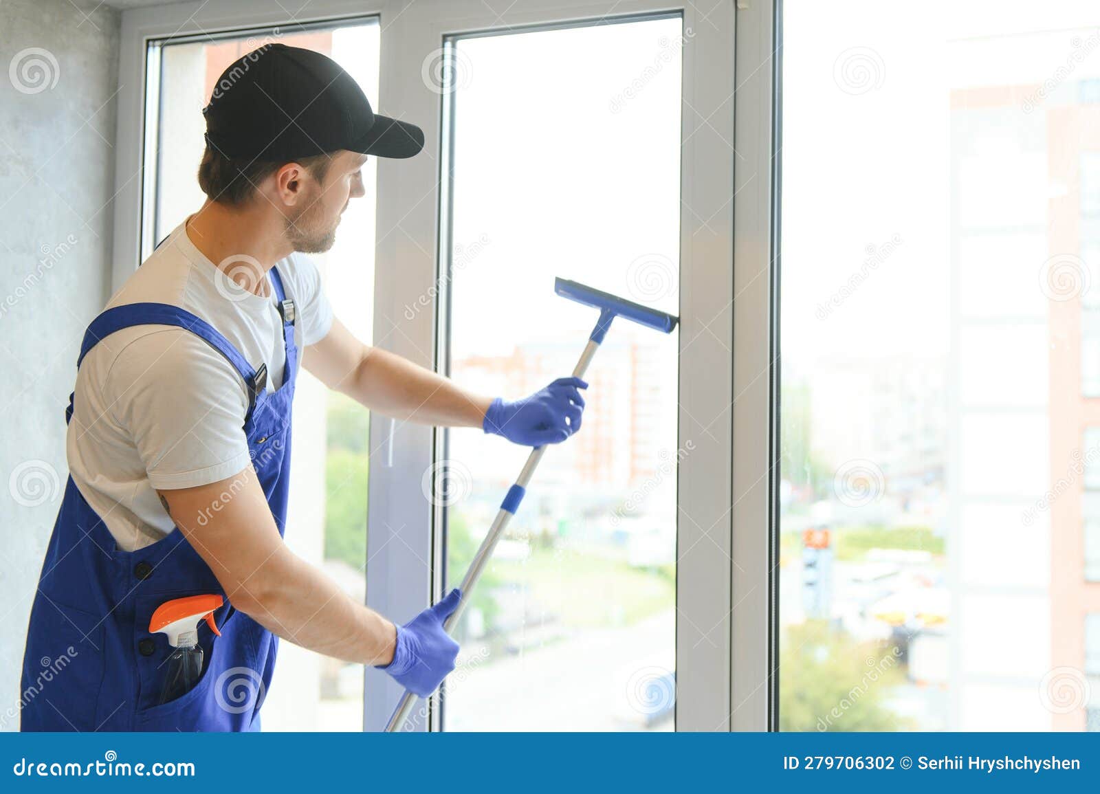 Young Man Cleaning Window in Office Stock Photo - Image of chores, flat ...