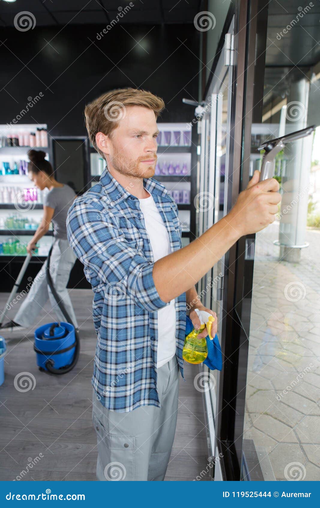 Young man cleaning windows stock photo. Image of squeegee - 119525444