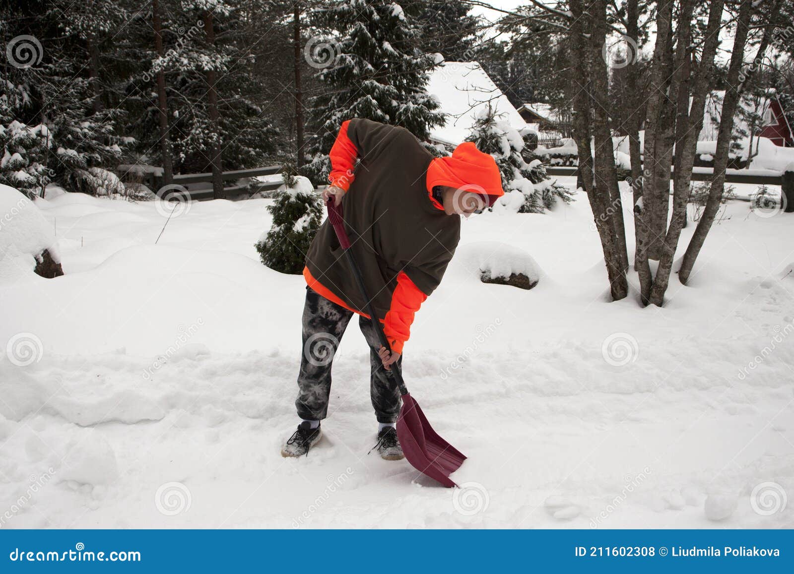 Young Man Cleans the Yard after a Snowfall. Guy Shoveling Snow Stock ...