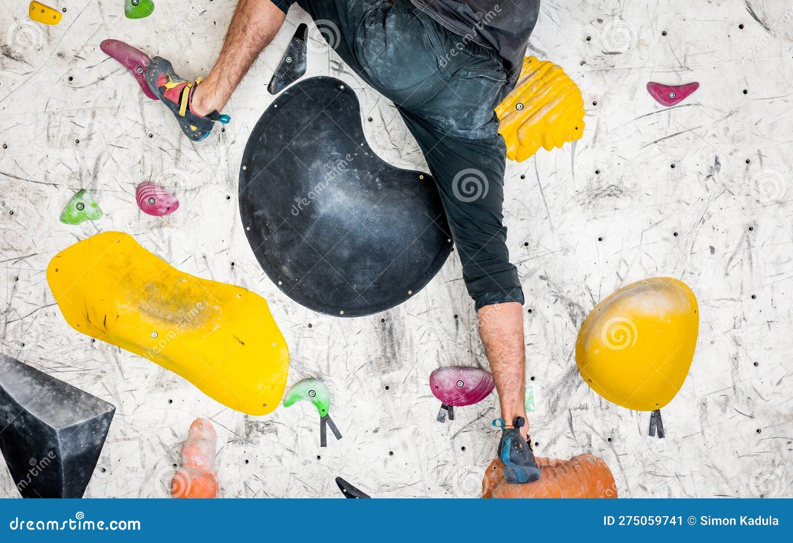 Young Man Climbing on the Indoor Climbing Wall with Chalked Hands Stock ...