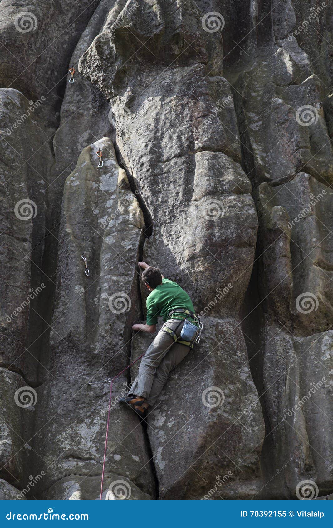 Young Man Climbs on a Cliff with a Rope. Stock Image - Image of ...