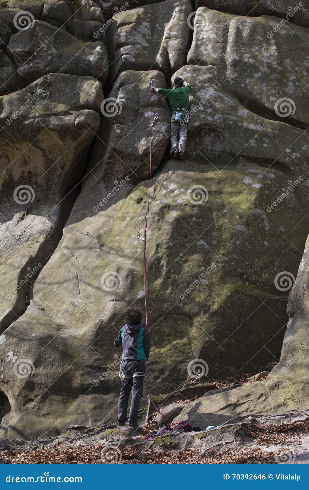 Young Man Climbs on a Cliff with a Rope. Stock Photo - Image of ...