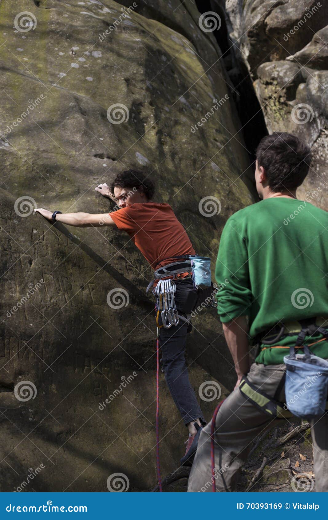 Young Man Climbs on a Cliff with a Rope. Stock Image - Image of ...