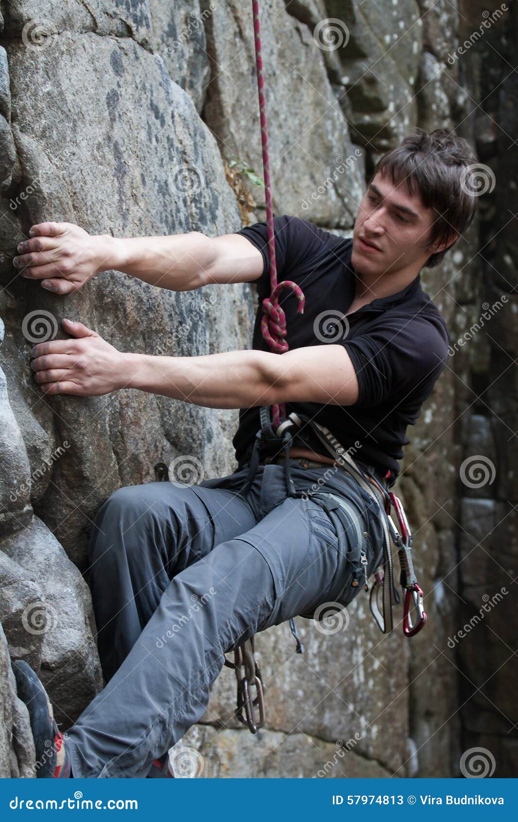 Young man climbs on a rock stock image. Image of activity - 57974813