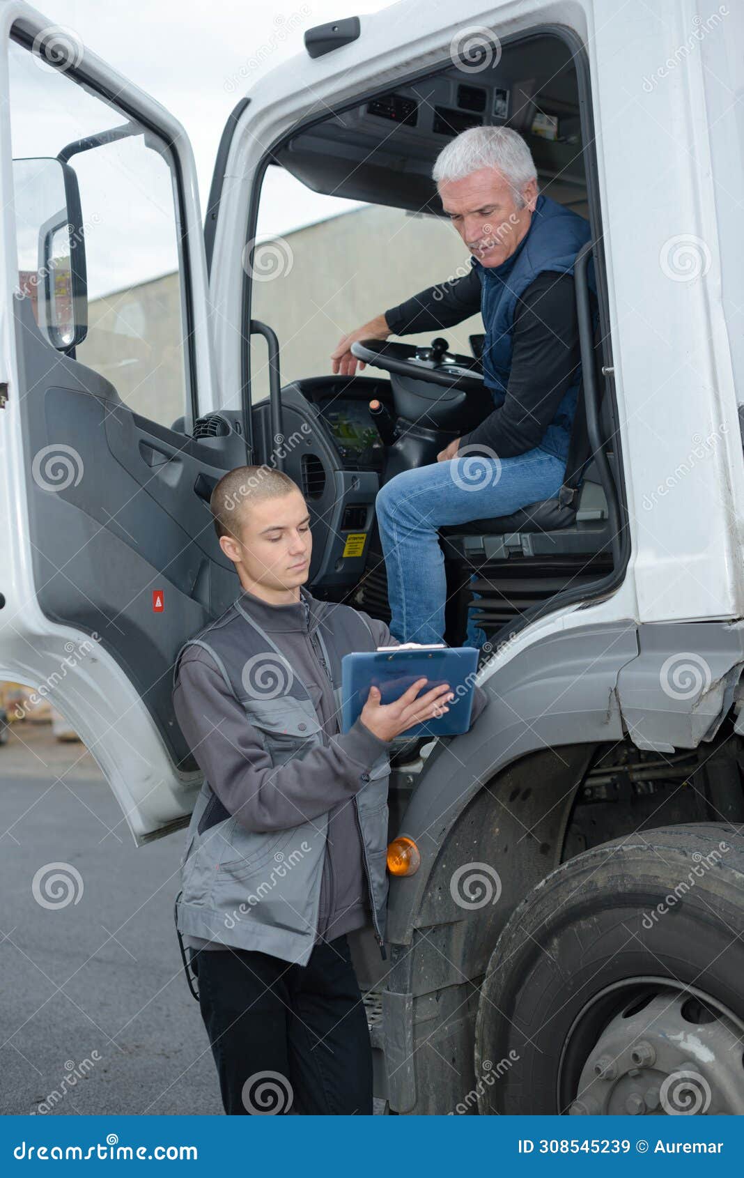 Young Man with Clipboard Giving Instructions To Lorry Driver Stock ...