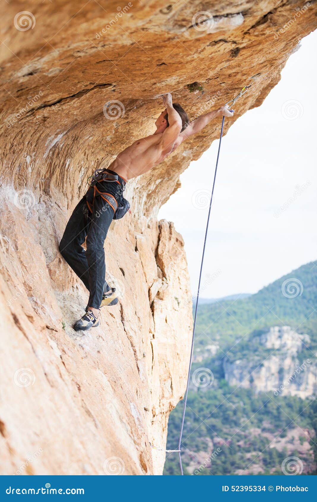 Young Man Clipping Rope While Clinging To Cliff Stock Photo - Image ...