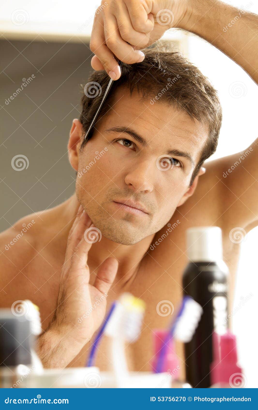 Young man combing his hair stock photo. Image of improvement - 53756270