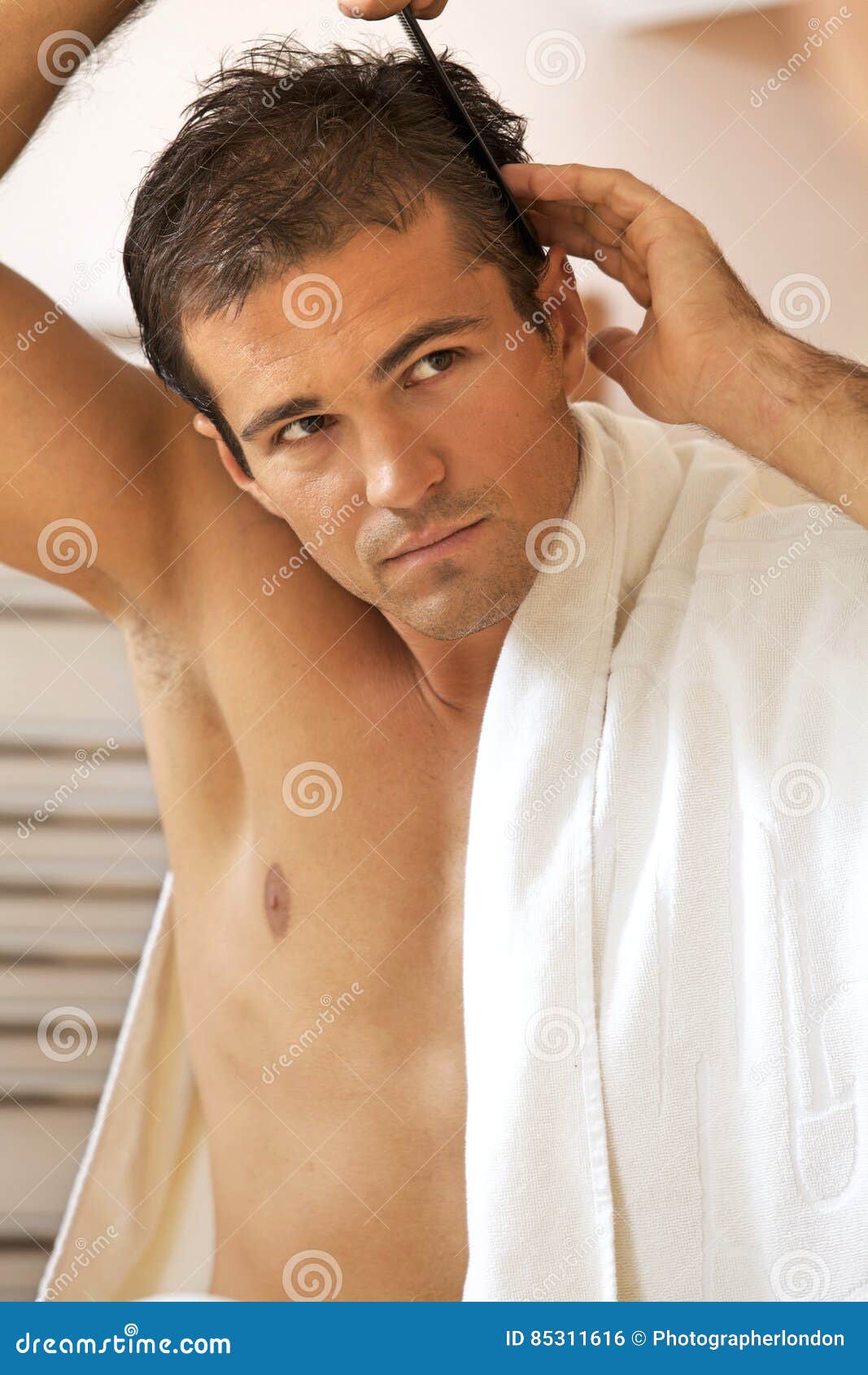 Young man combing his hair stock photo. Image of appearance - 85311616