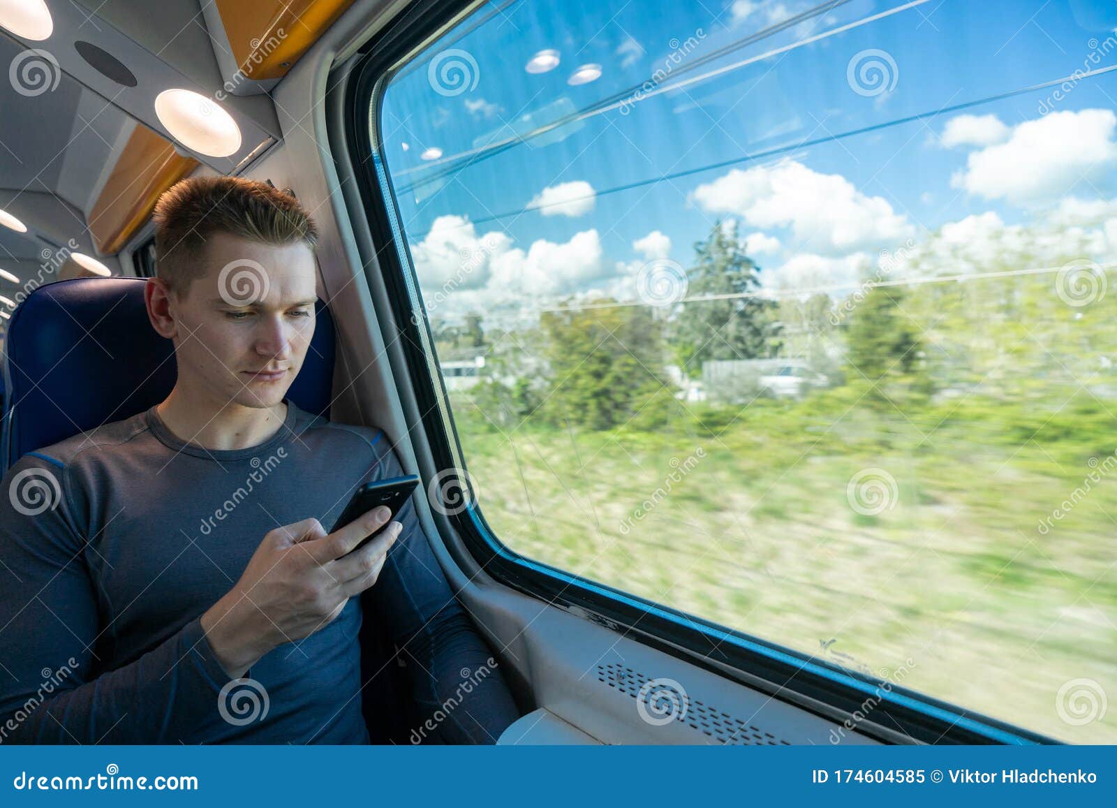 Young Man Commuting on Train Using Mobile Phone Stock Image - Image of ...