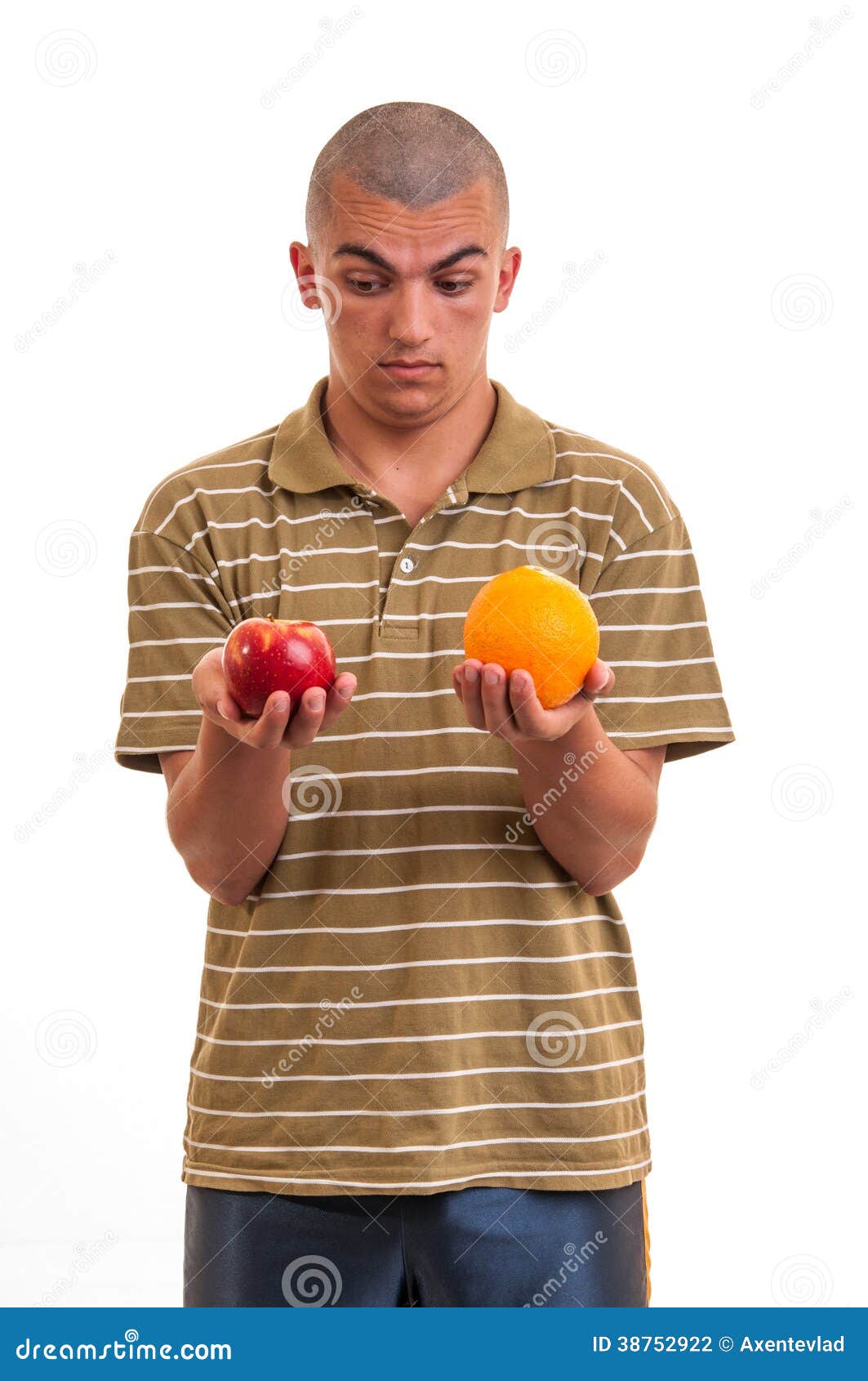Young Man Comparing an Apple To an Orange Stock Photo - Image of juicy ...