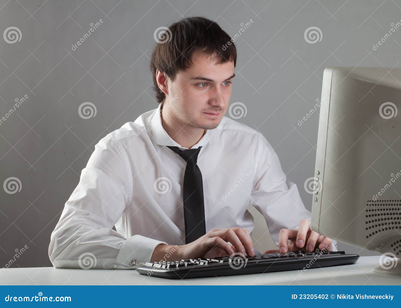 Young man at the computer stock photo. Image of brunette - 23205402
