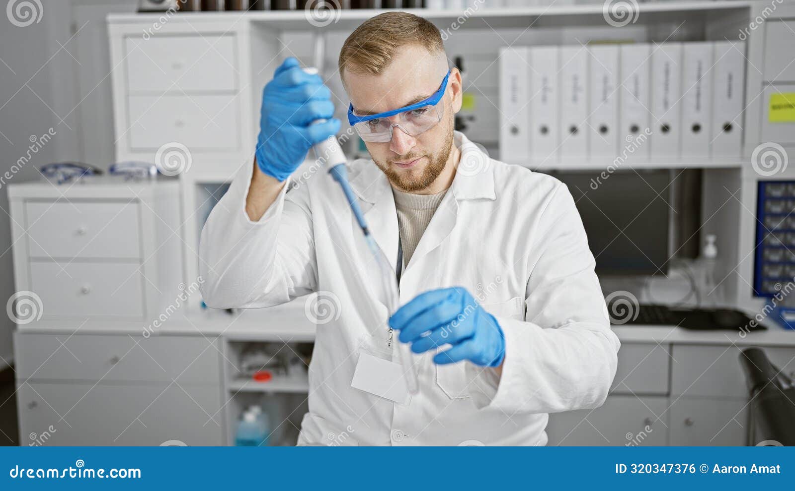 A Young Man Conducting an Experiment in a Laboratory Setting, Focused ...