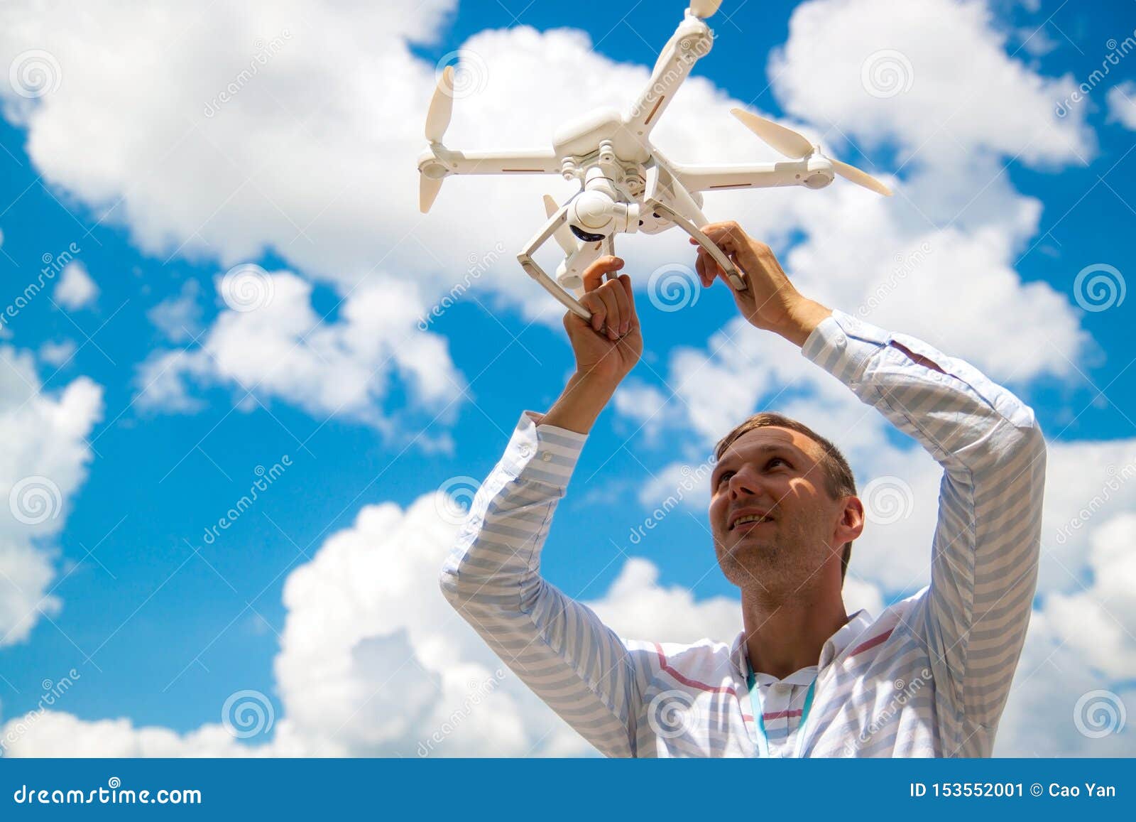 Young Man Controlling Drone in Field. Drone Operator Holding a ...