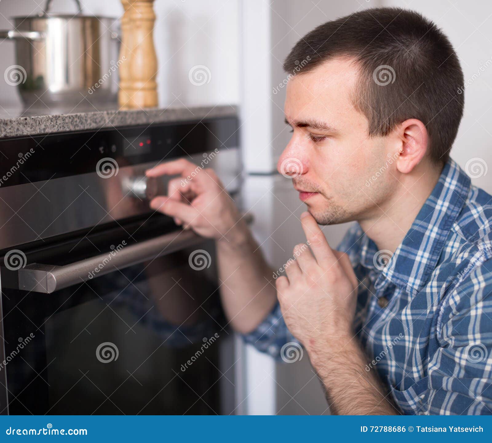 Young Man Controls the Oven in the Kitchen Stock Photo - Image of ...