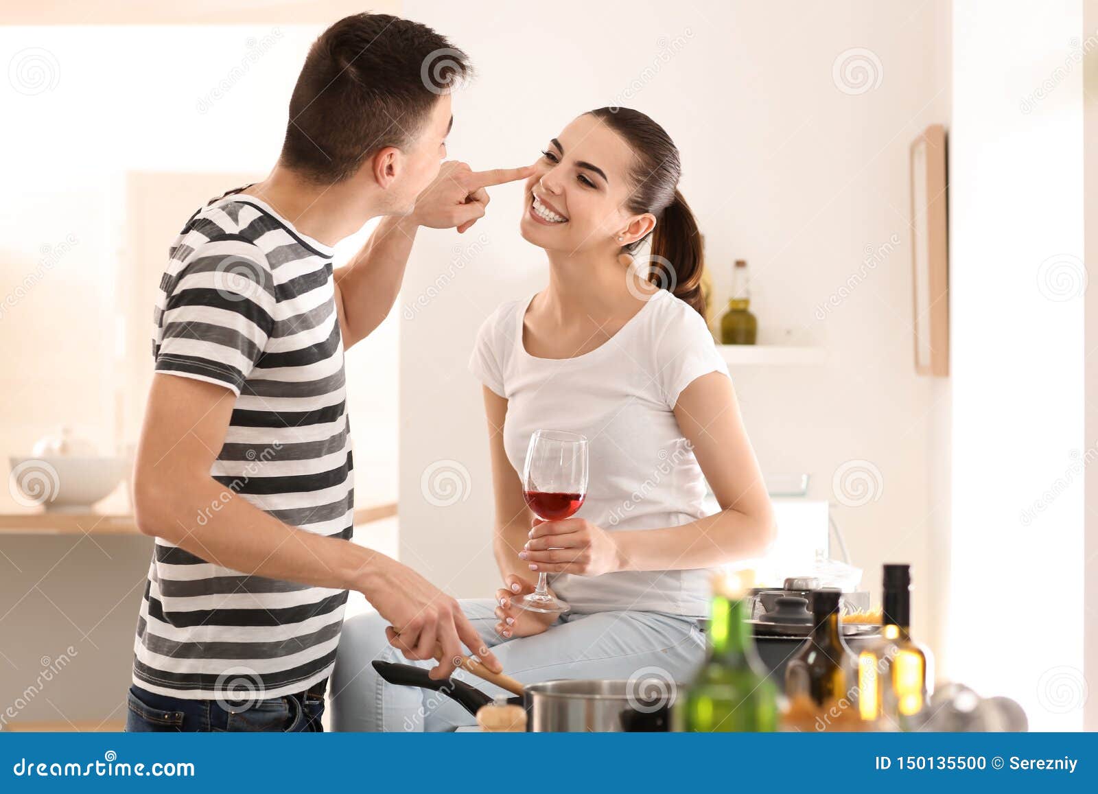 Young Man Cooking with Girlfriend in Kitchen Stock Photo - Image of ...