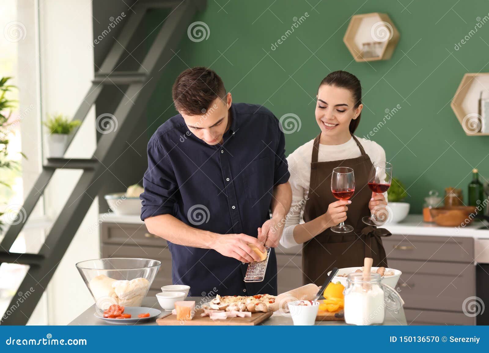 Young Man Cooking with Girlfriend in Kitchen Stock Photo - Image of ...