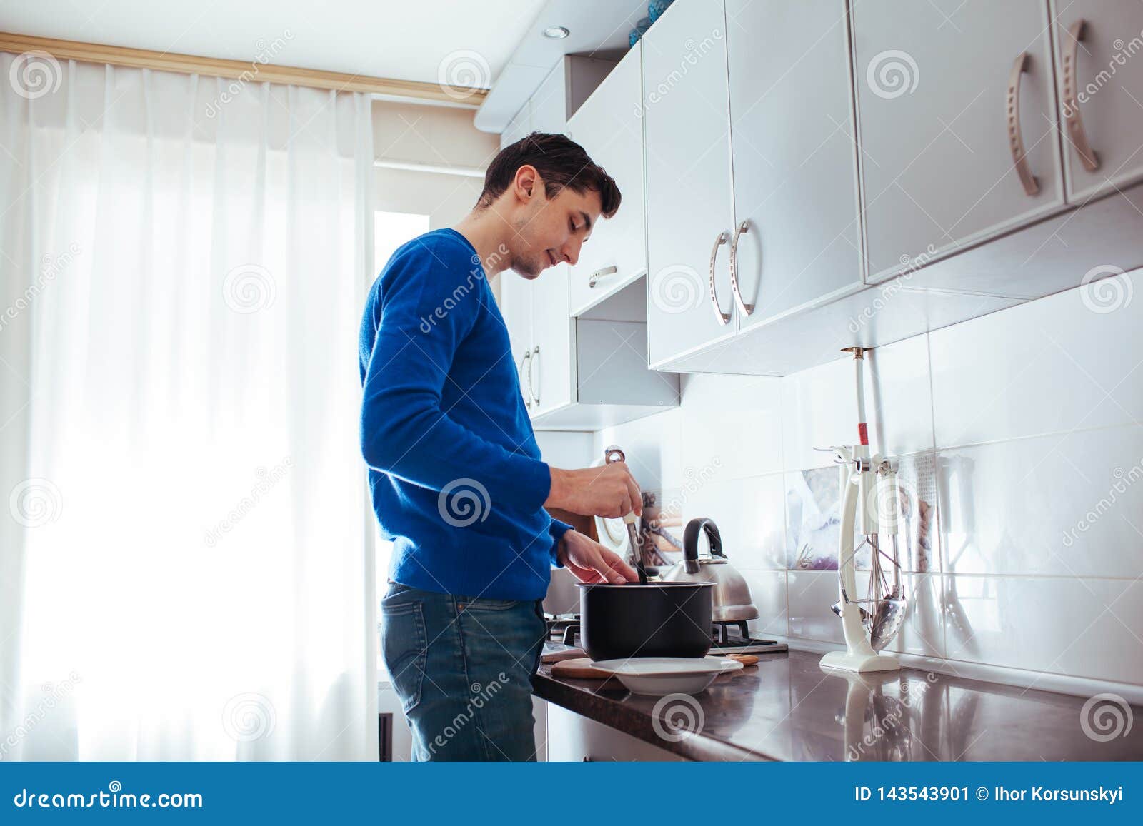 Young Man Cooking in the Kitchen at Home Stock Image - Image of cook ...