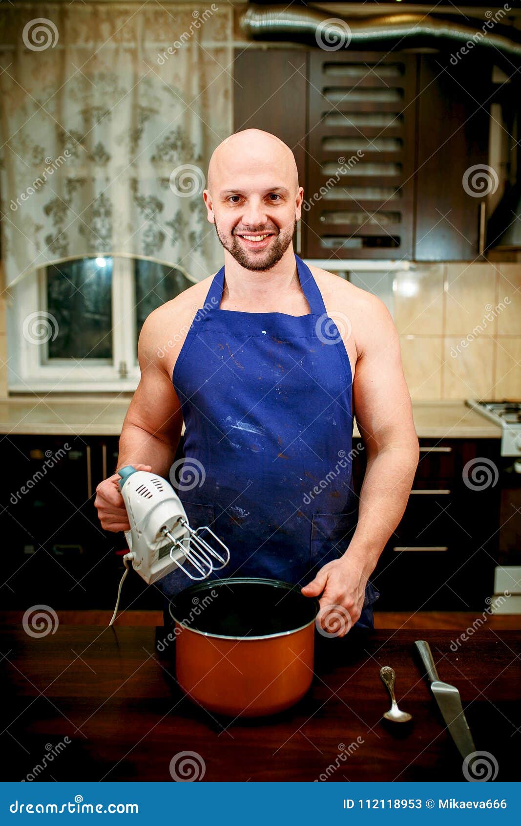 A Young Man is Cooking in a Large Kitchen Stock Image - Image of bowl ...