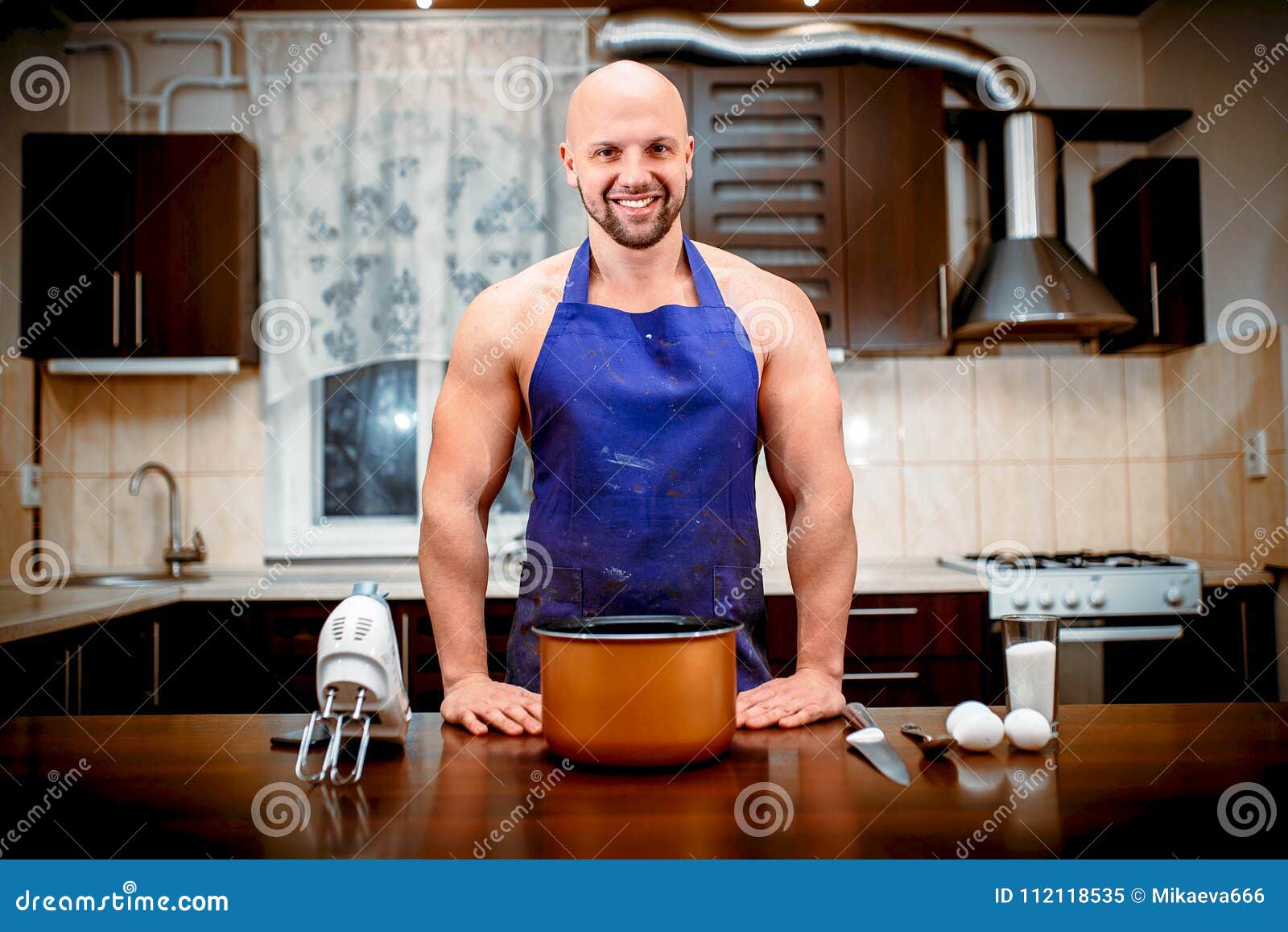 A Young Man is Cooking in a Large Kitchen Stock Image - Image of ...