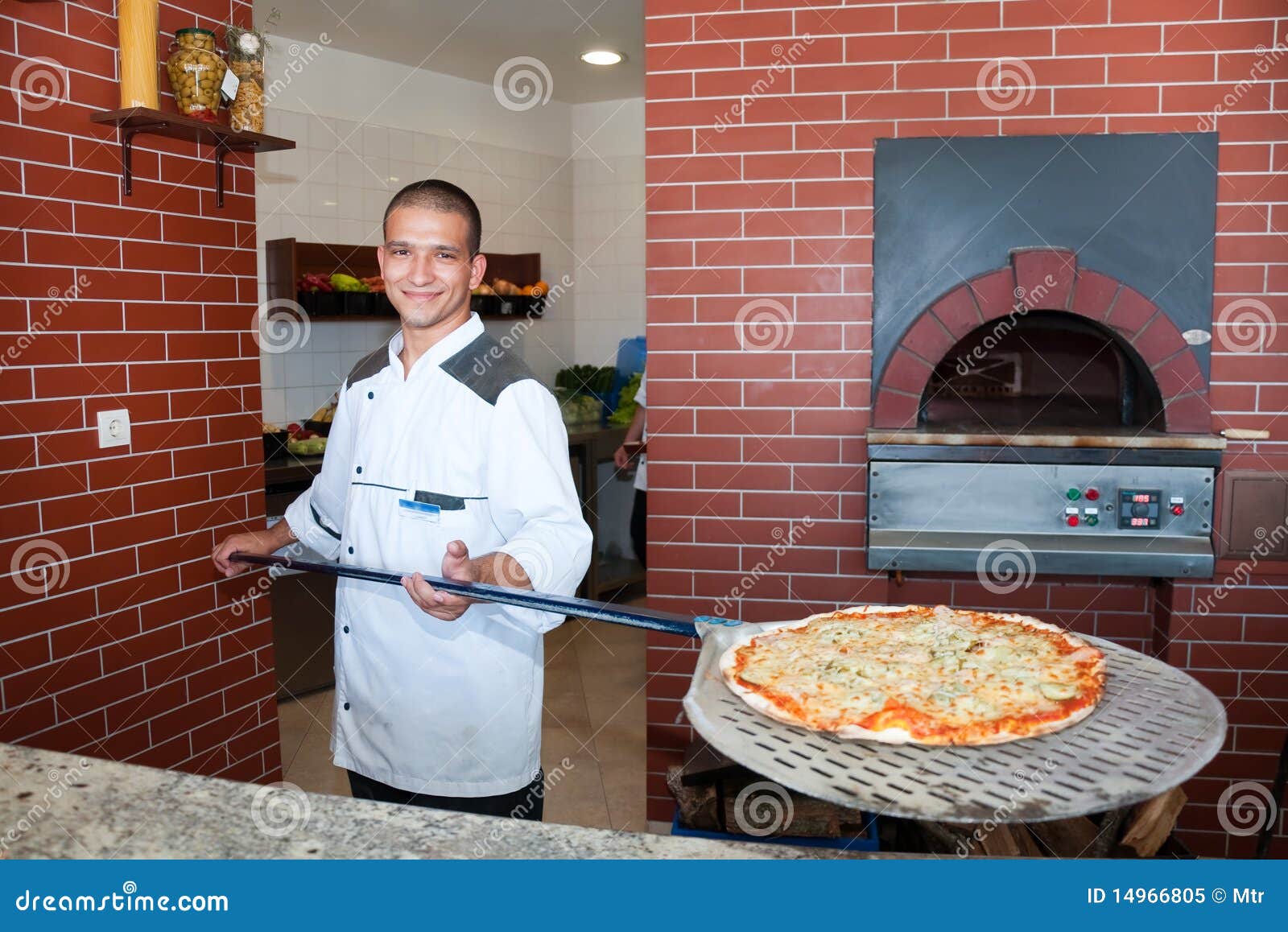 Young man cooking pizza stock image. Image of cooking - 14966805
