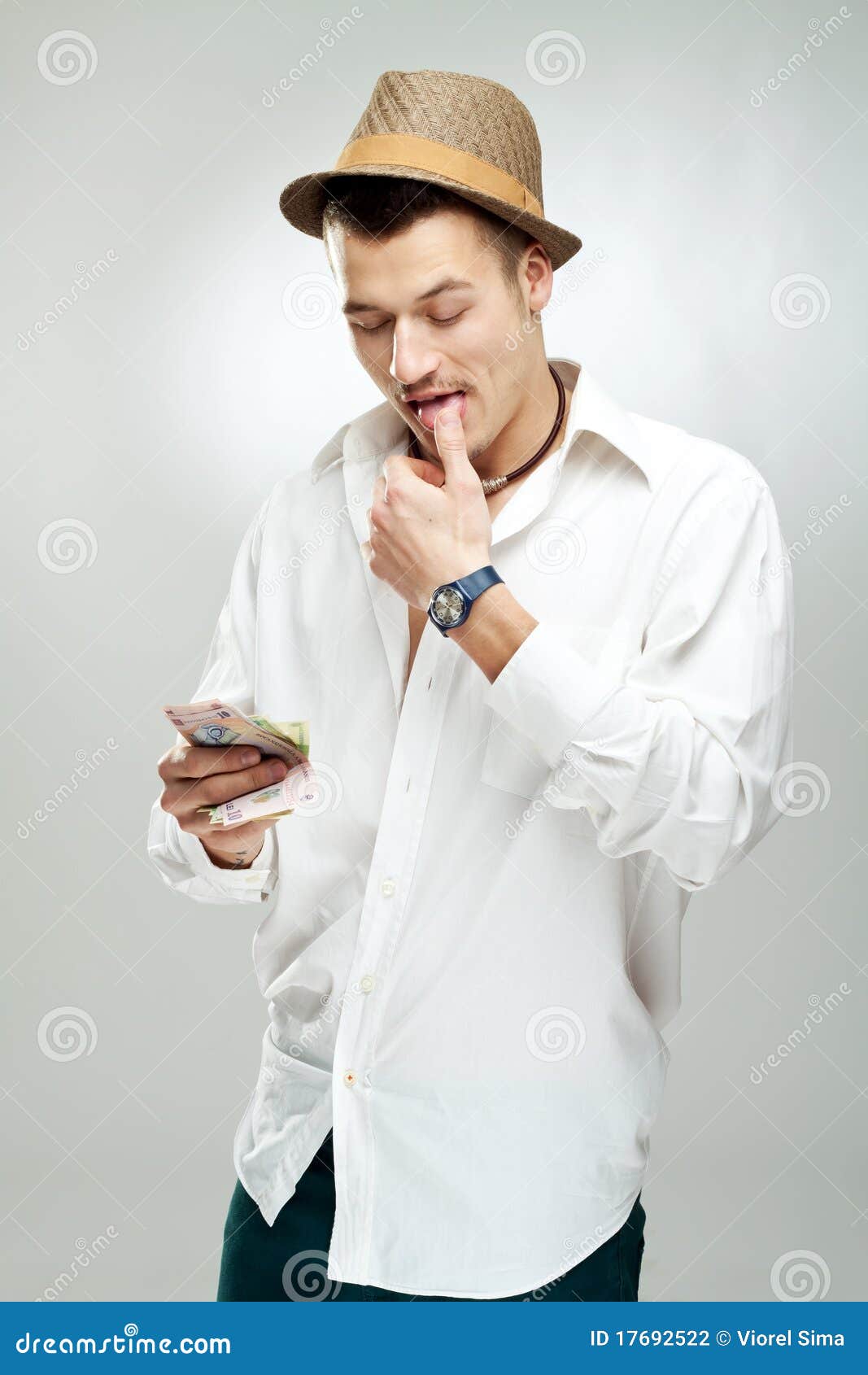 Young Man Counting Money stock photo. Image of tough - 17692522