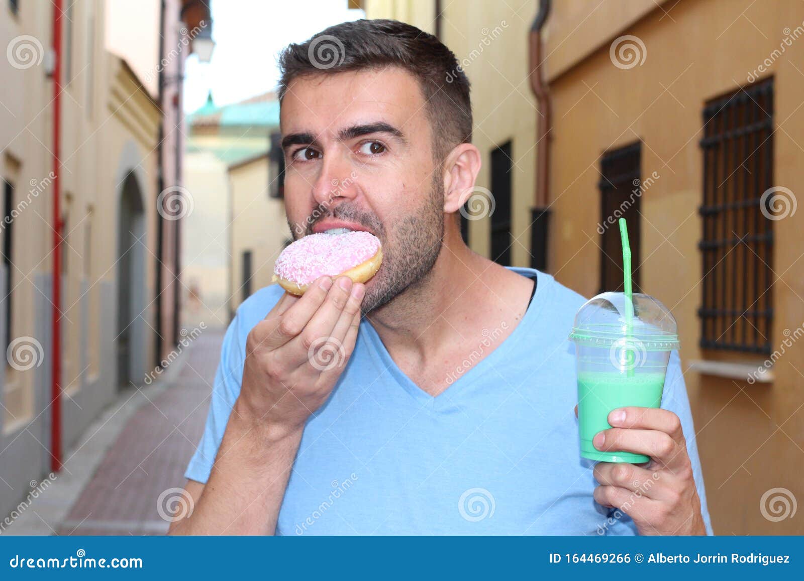 Young man craving a donut stock photo. Image of diabetic - 164469266