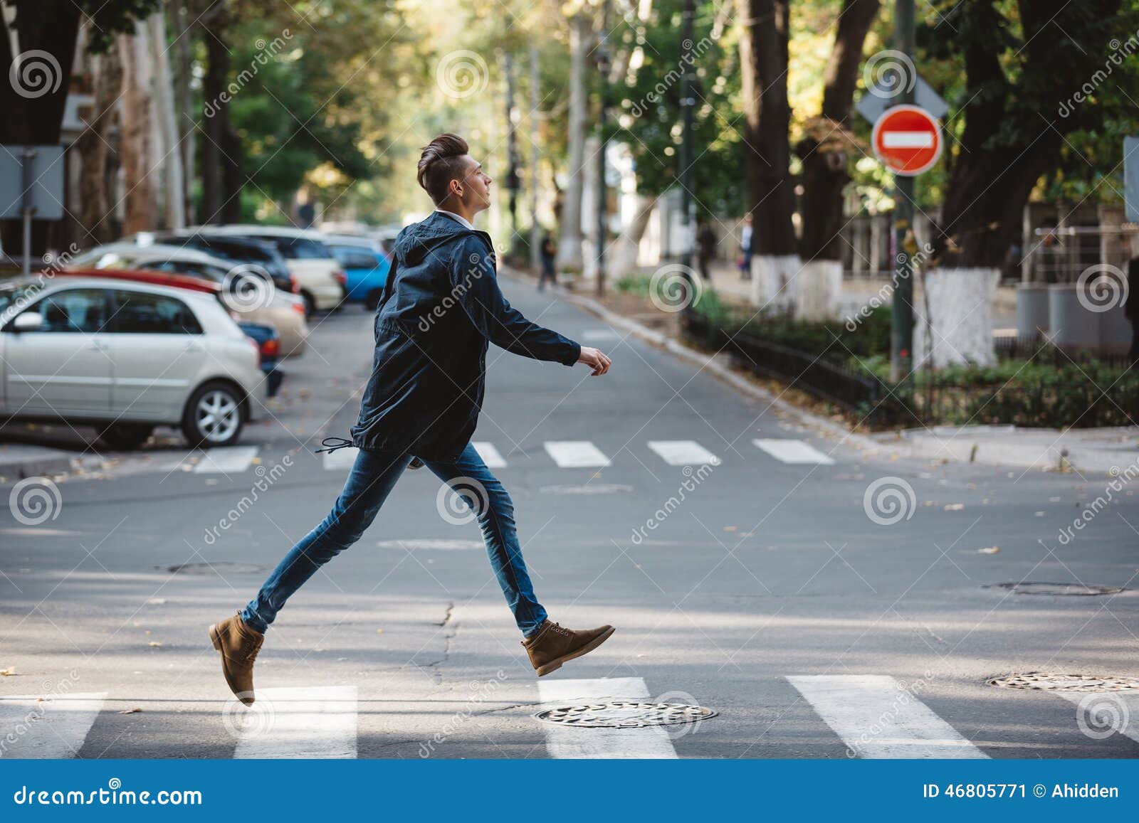 Young man cross the street stock image. Image of walk - 46805771