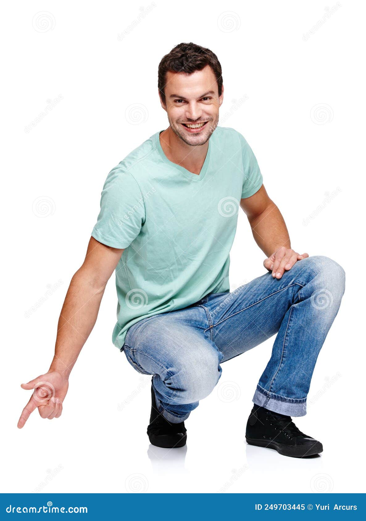 Look Down Here. a Young Man Crouching and Pointing Towards Something ...