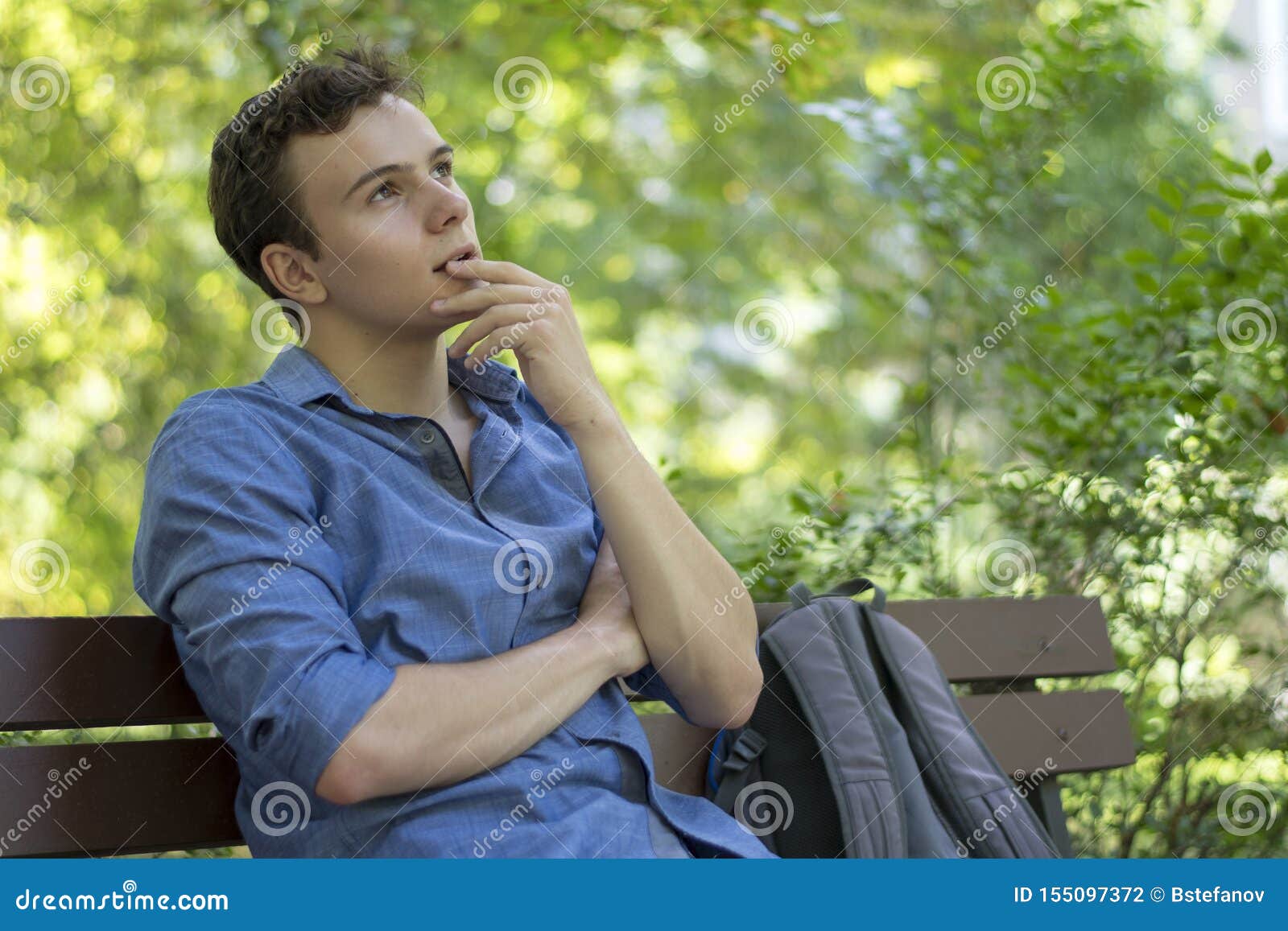 Young man day dreaming stock photo. Image of person - 155097372