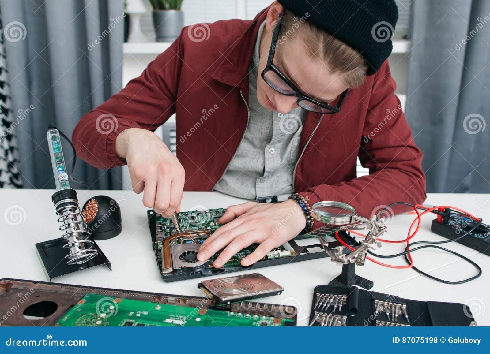 Young Man Disassembling Computer Motherboard. Stock Photo - Image of ...